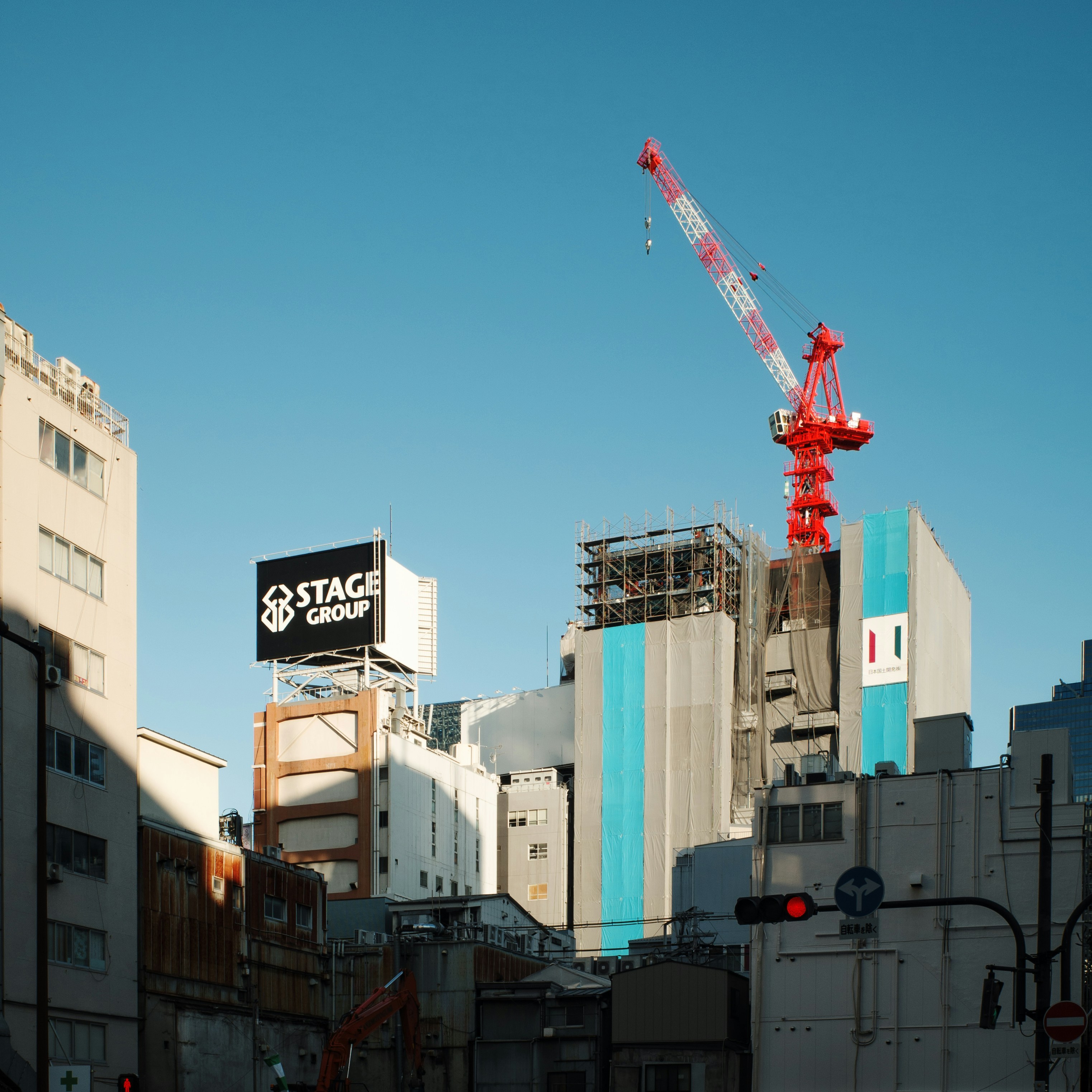 Crane Crown over a Sunlit City Under Construction
