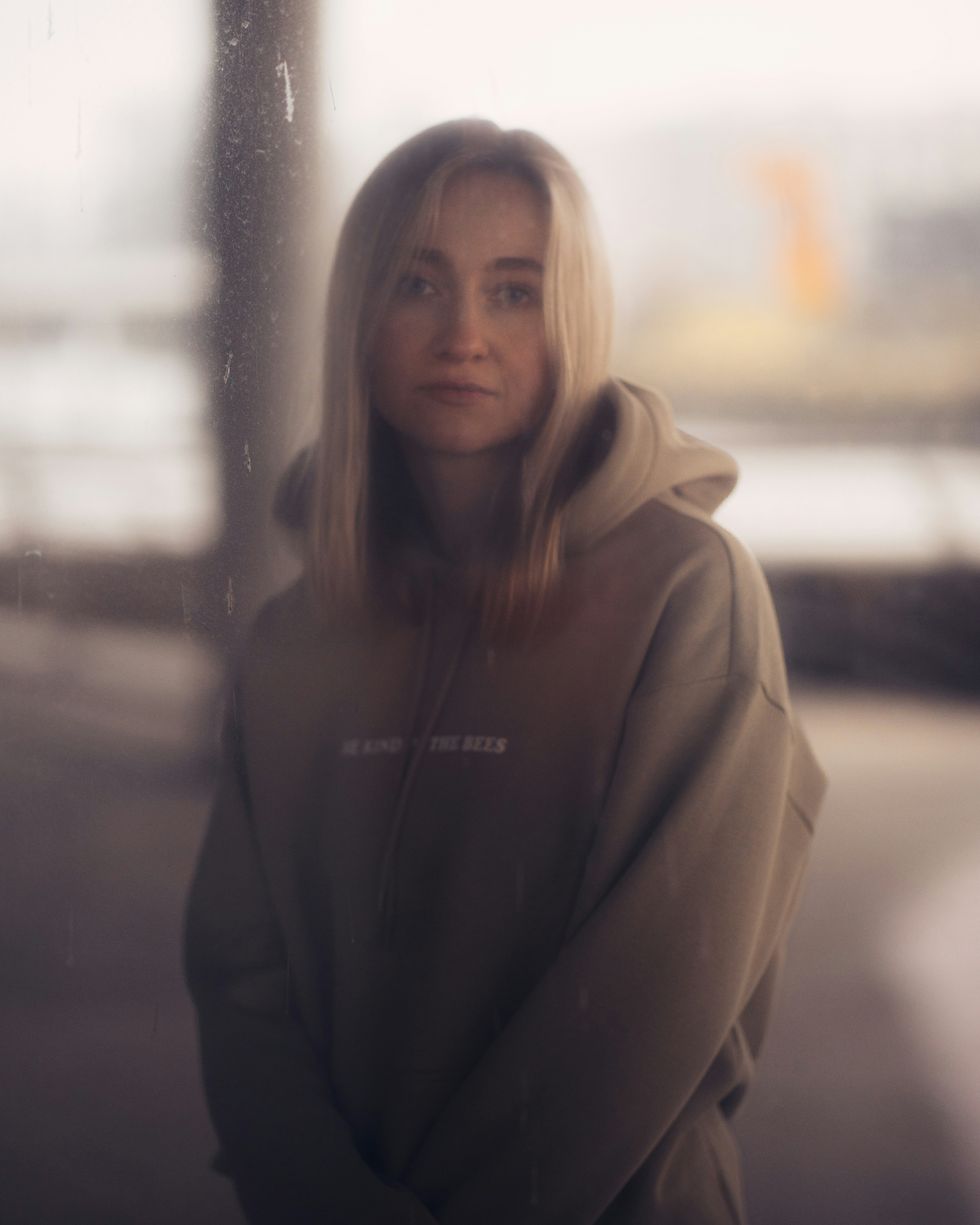Young woman poses for a photo in neutral colors.