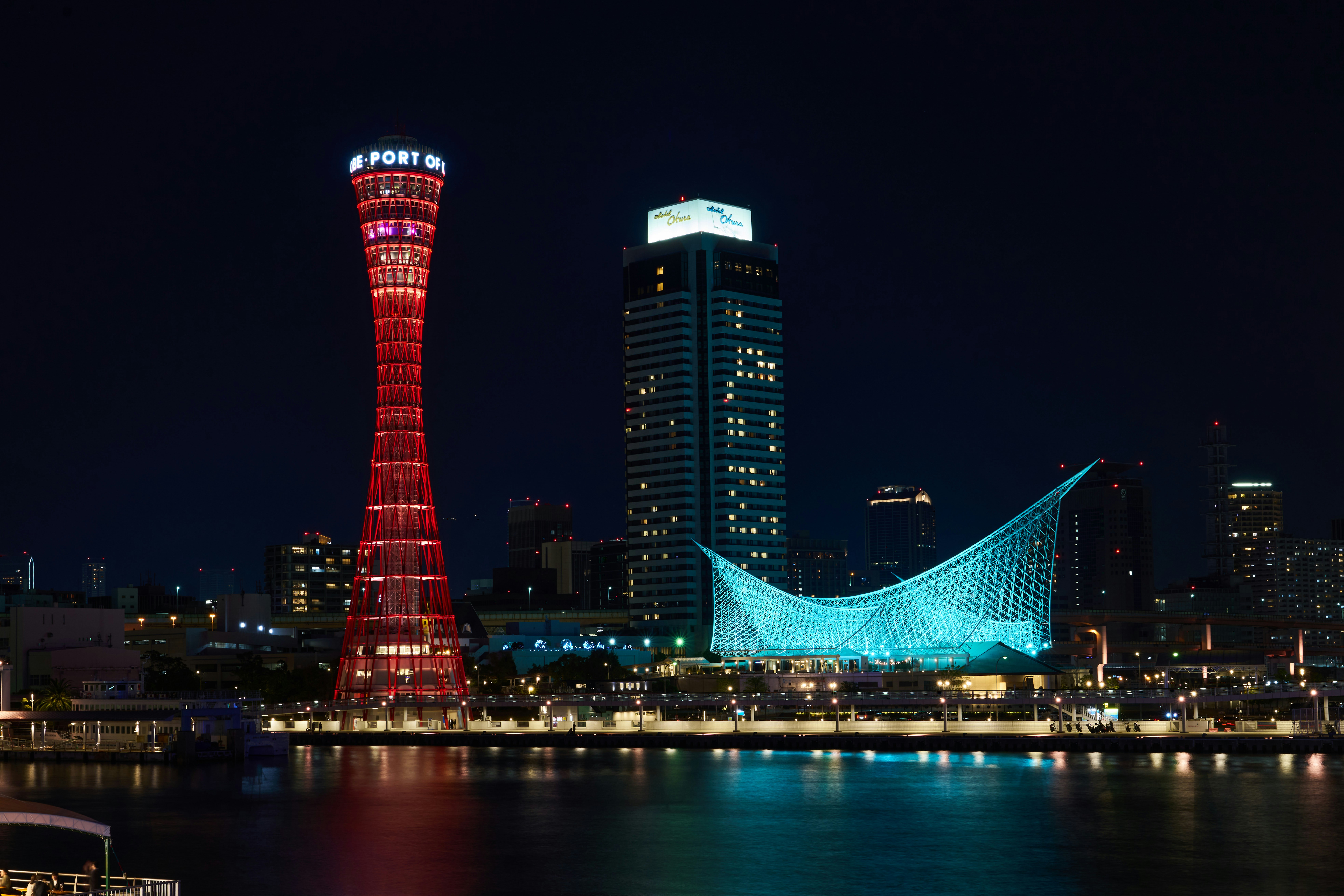 Crimson Spire and Sapphire Sail: Kobe Harbor at Night