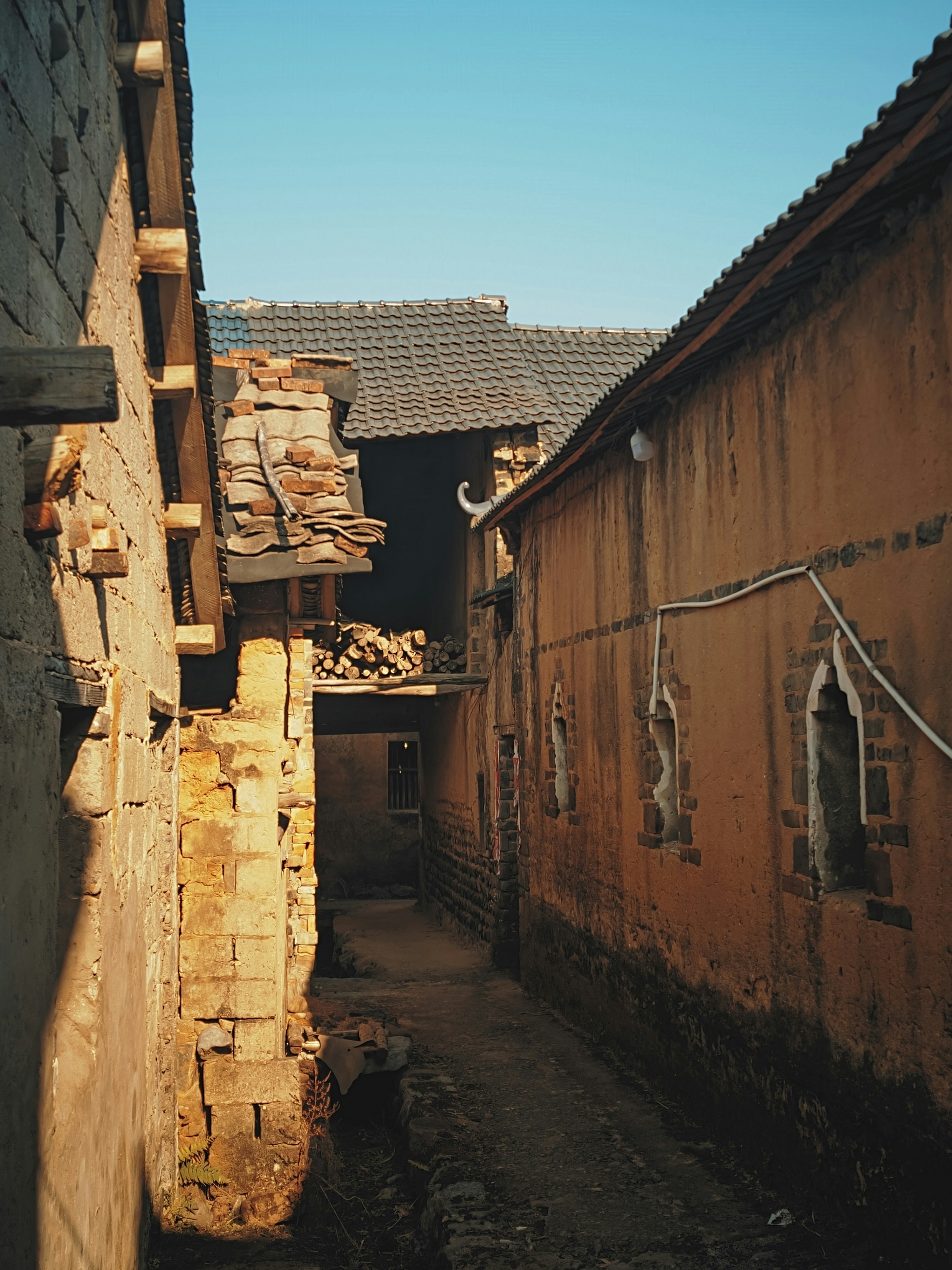 A narrow alleyway between ancient buildings.