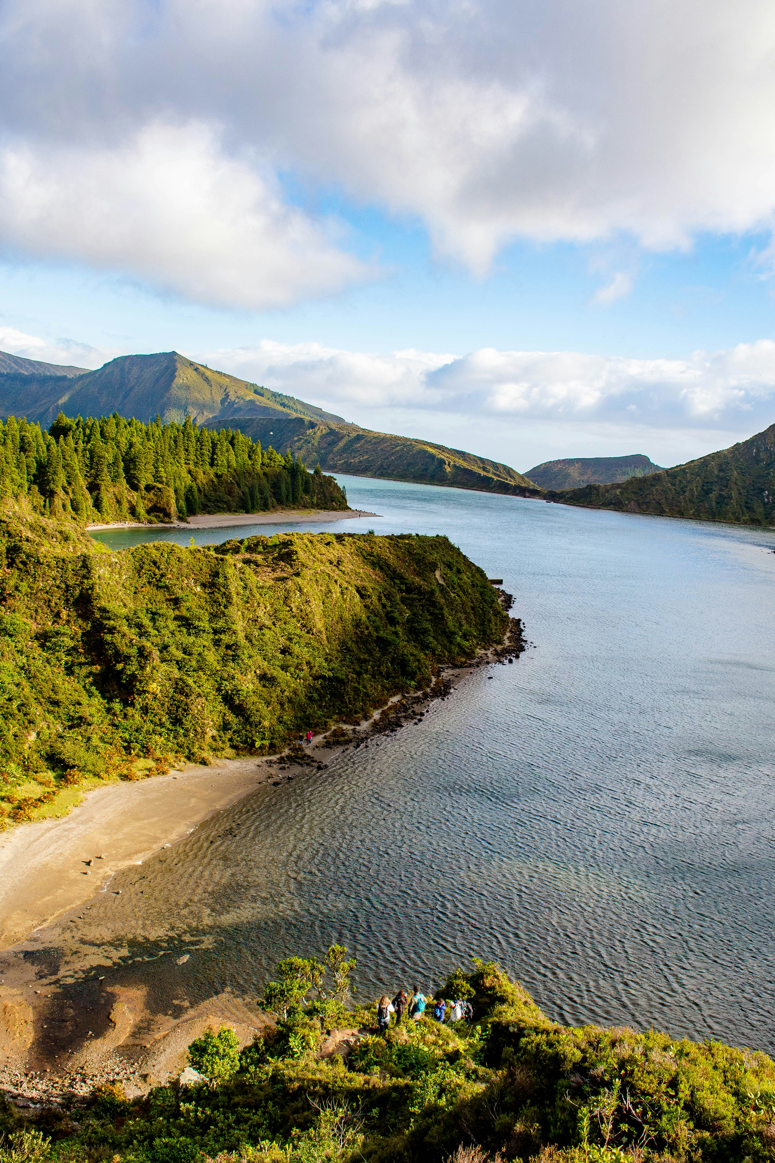 A winding river meanders through lush greenery and hills, showcasing the harmony of nature. The tranquil scene invites exploration and reflection.