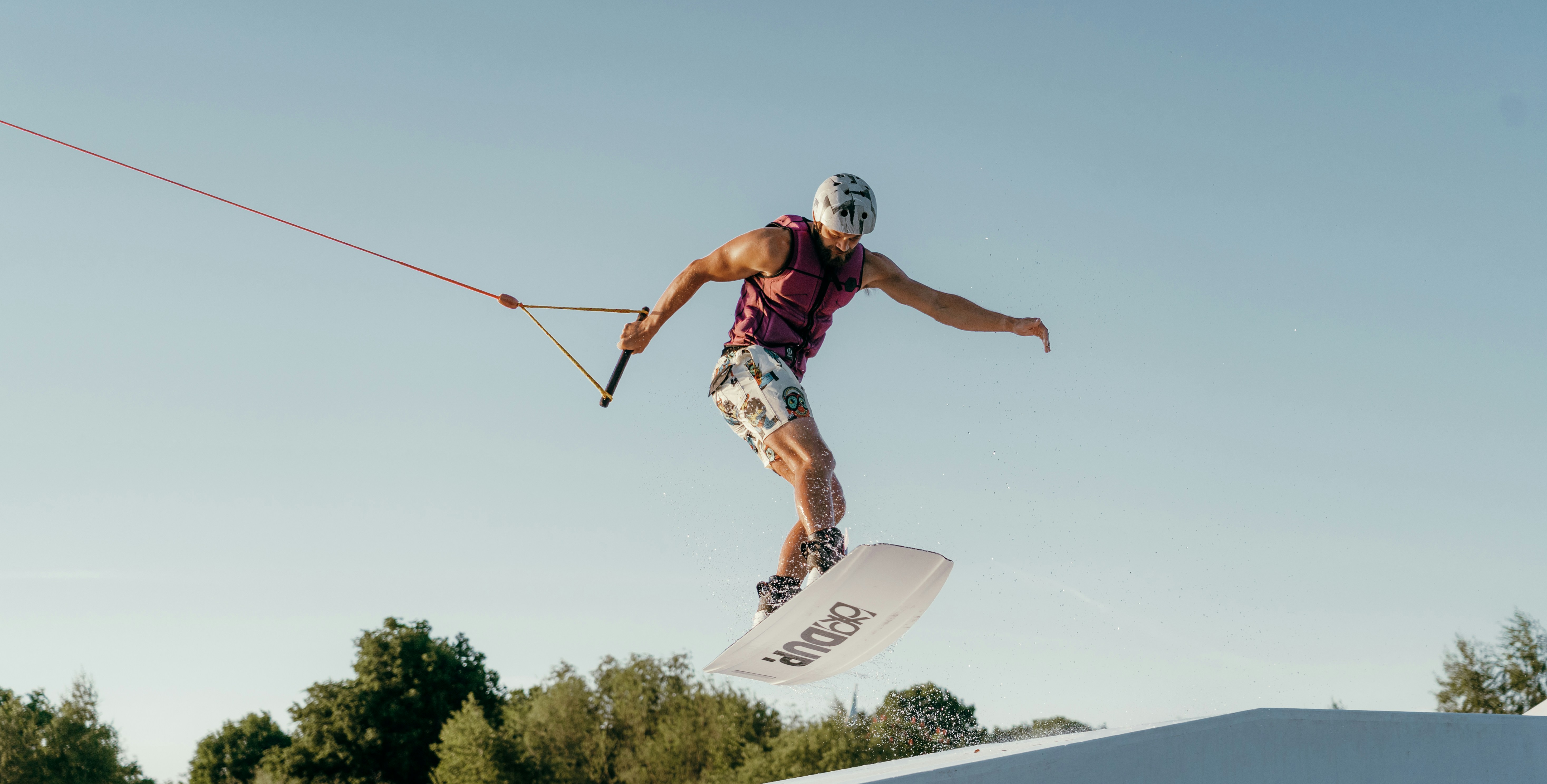 Tow-Line Aerial: Wakeboarder Cuts the Crisp Blue Sky