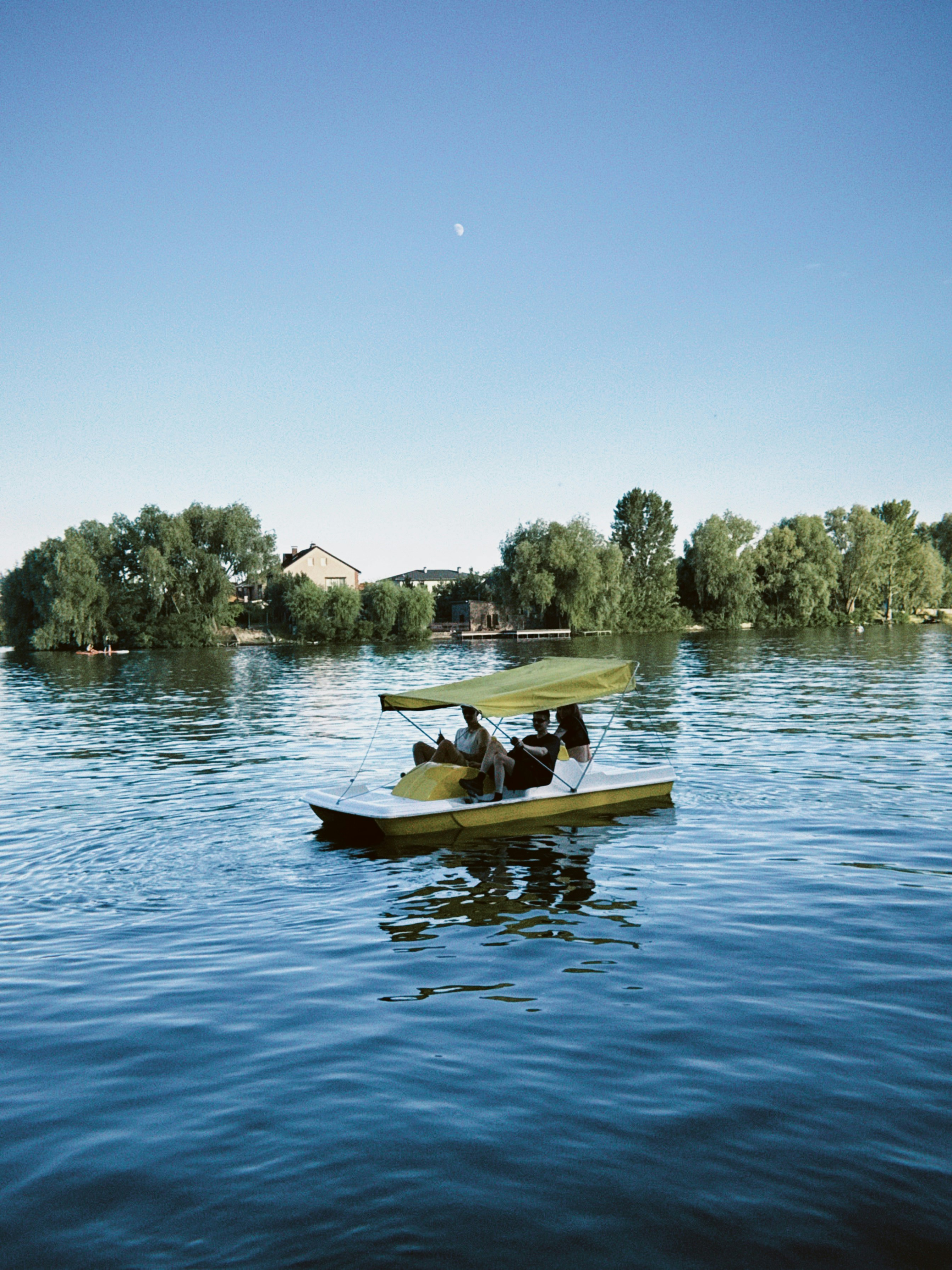 People enjoy a boat ride on the lake.