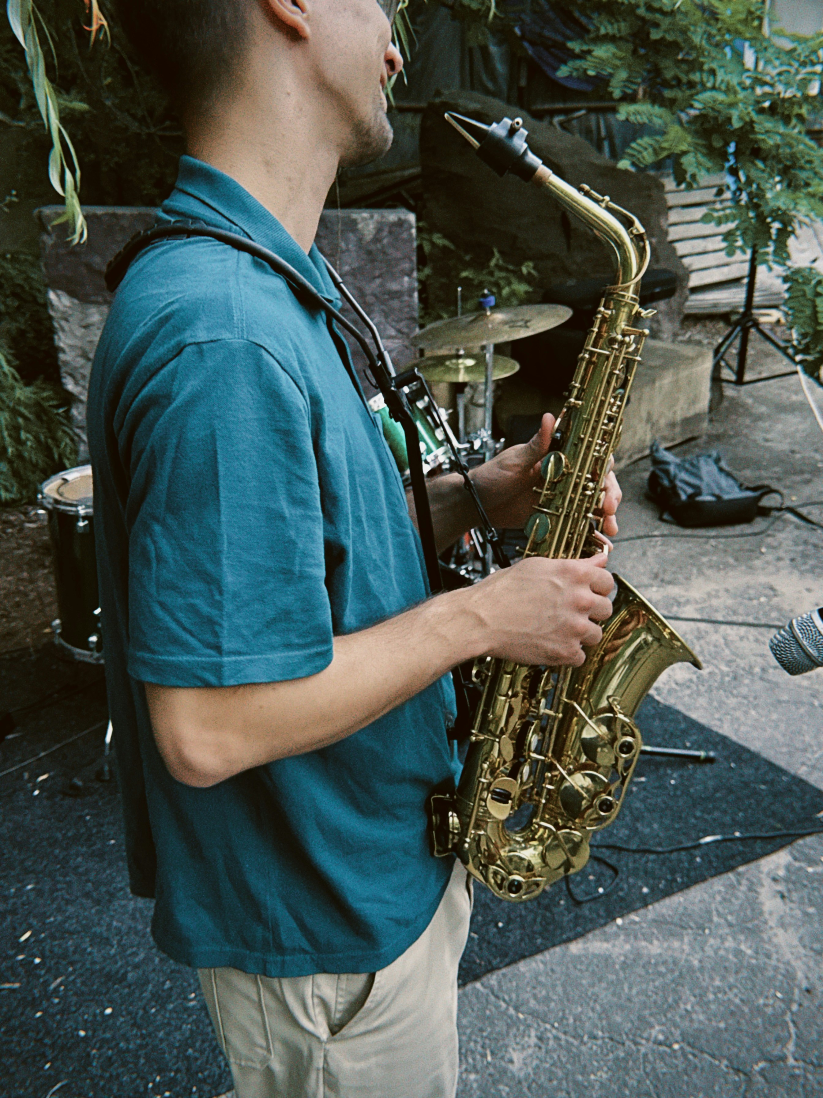 A man plays a shiny golden saxophone.