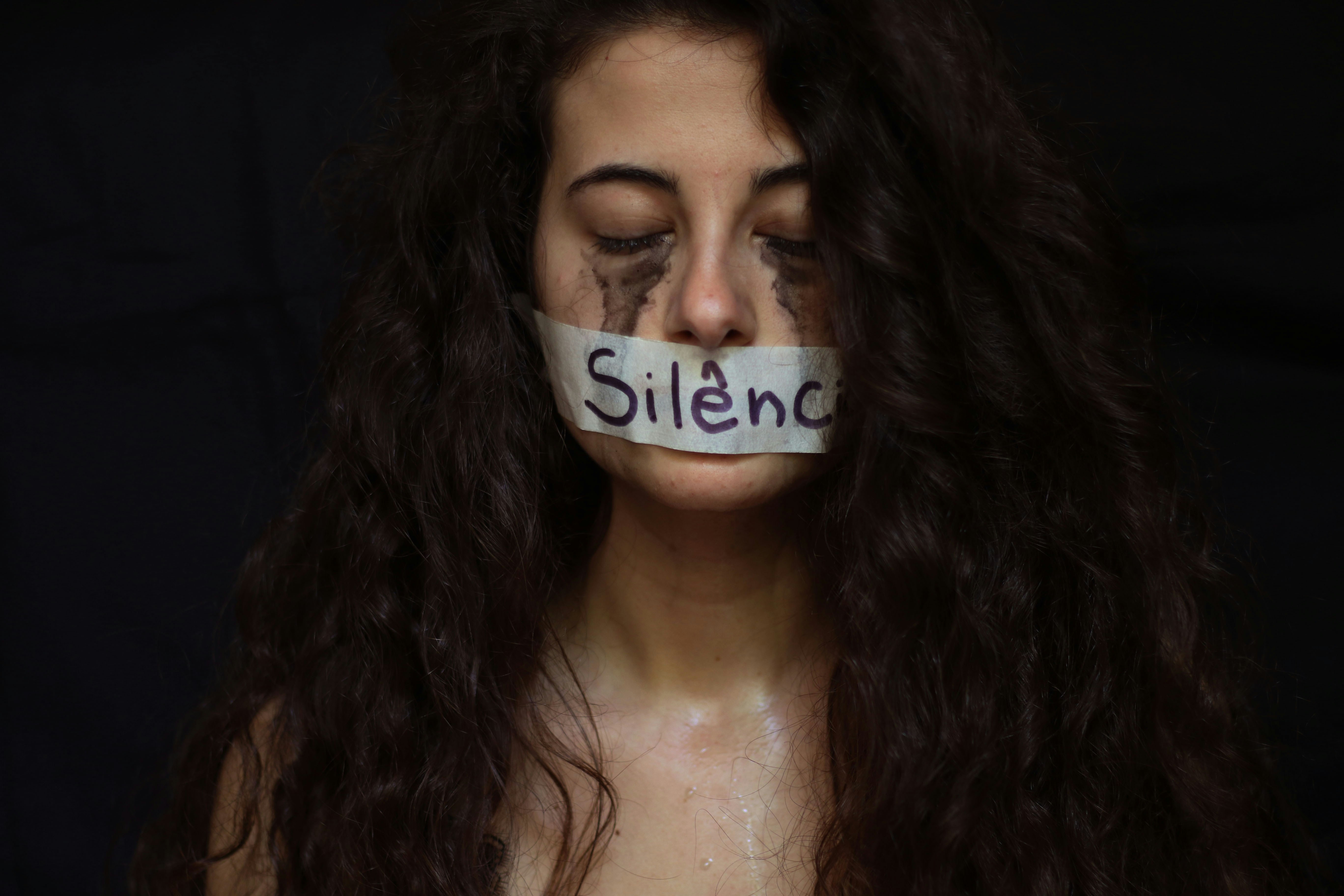 Silence symbolized by tape on a woman's mouth. photo – Free Woman Image ...