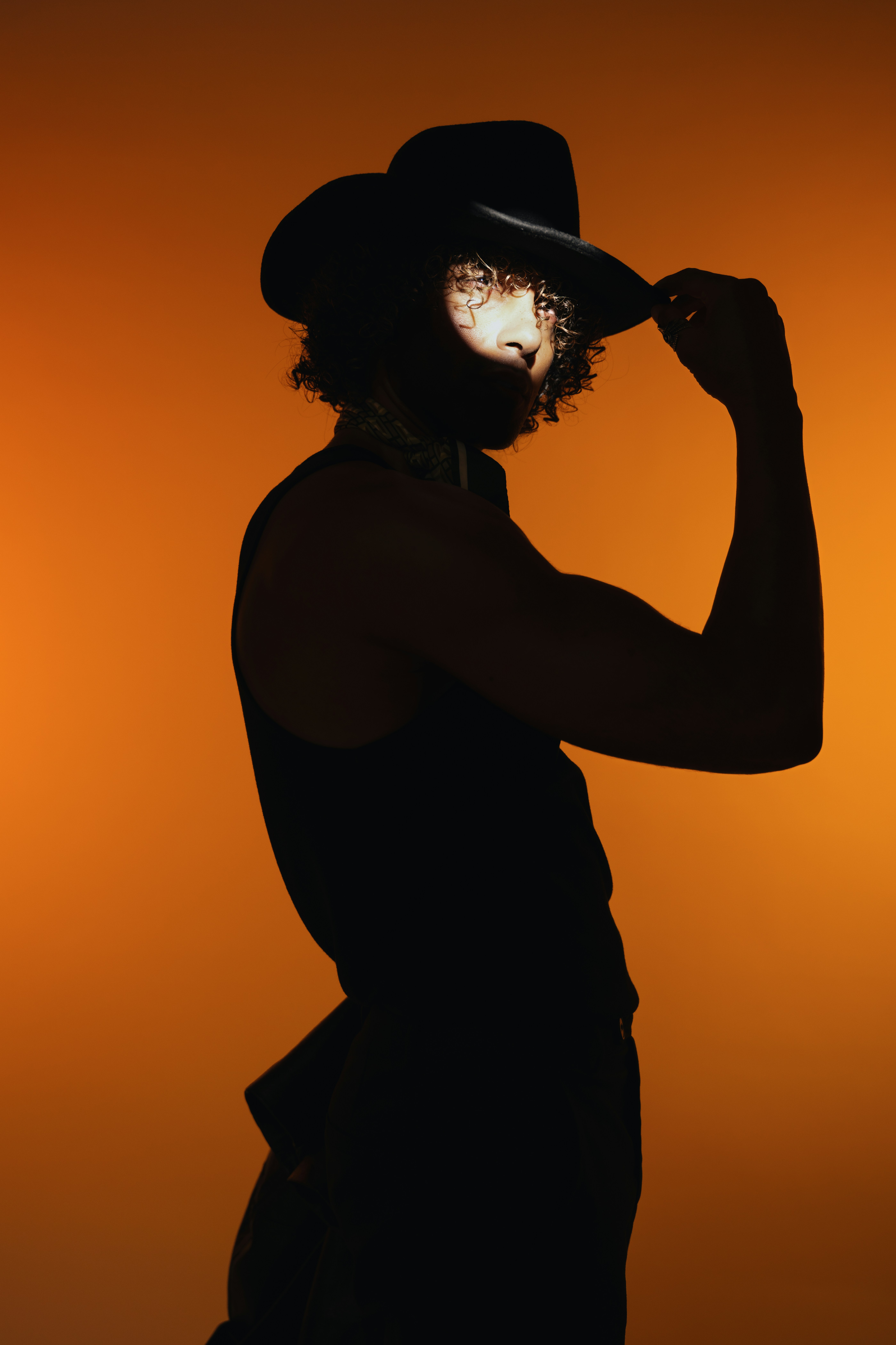 Silhouette of a person wearing a cowboy hat.