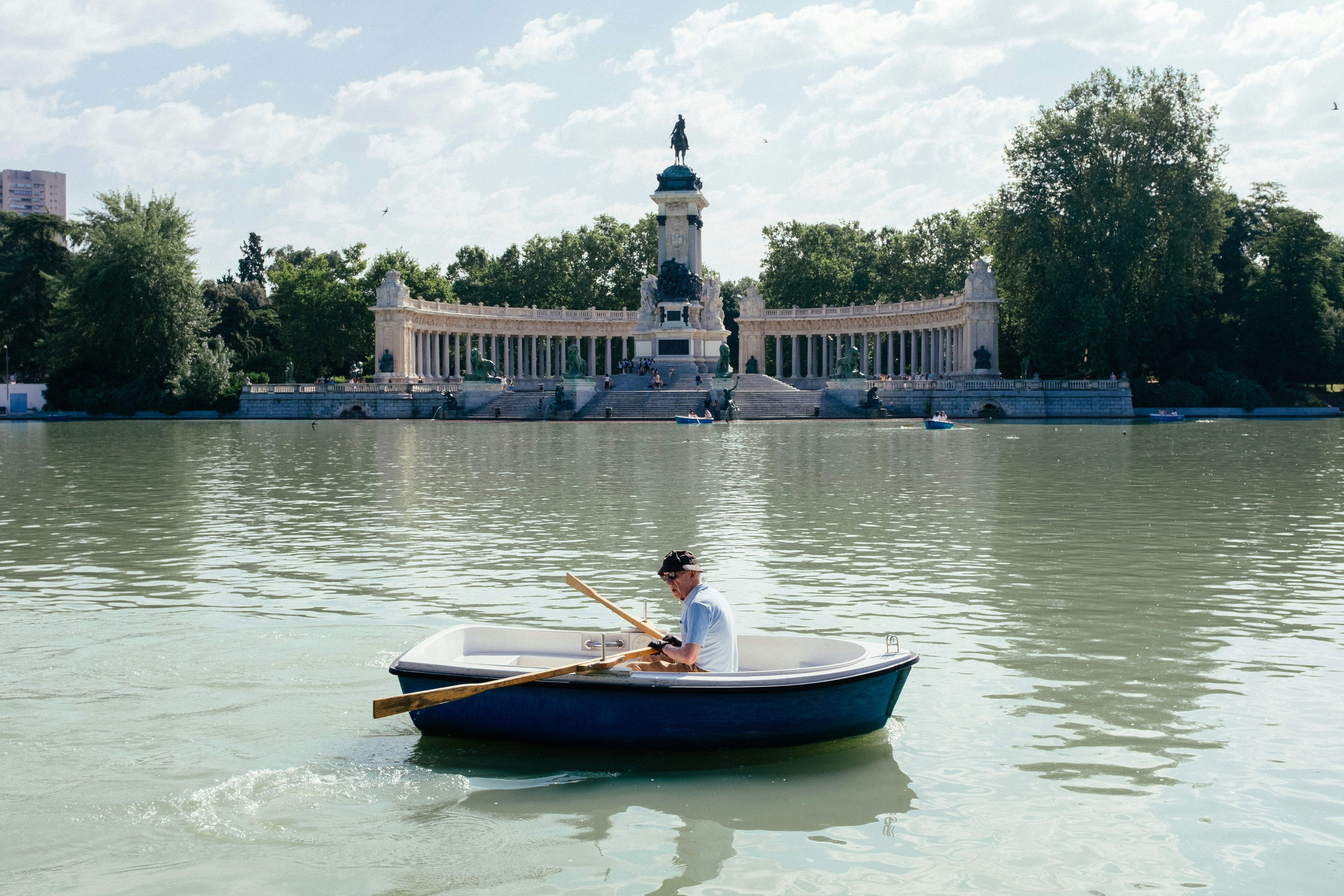 Boatman on a Quiet Lake with a Grand Monument Backdrop