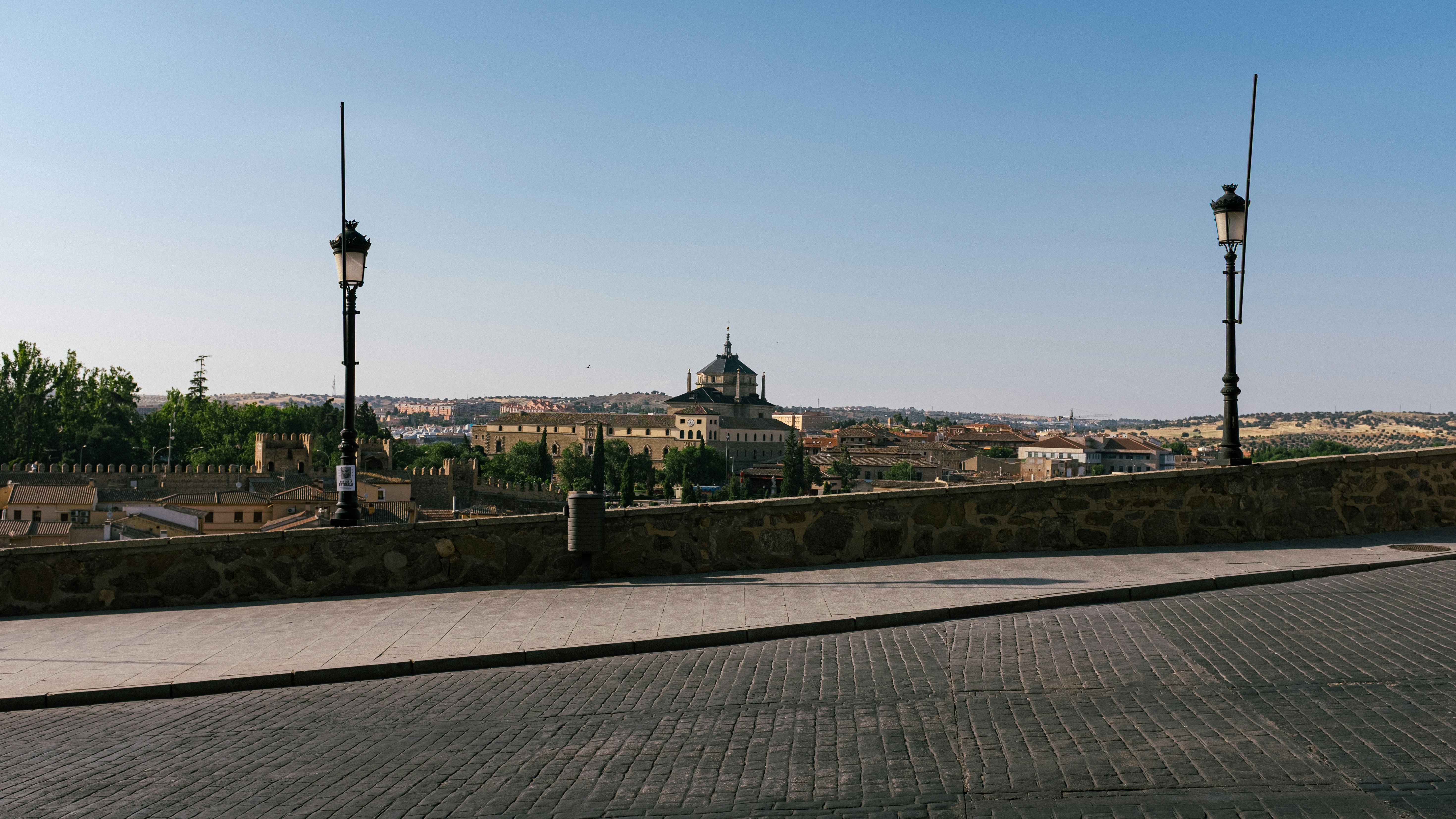 Cityscape view from a street with lampposts.