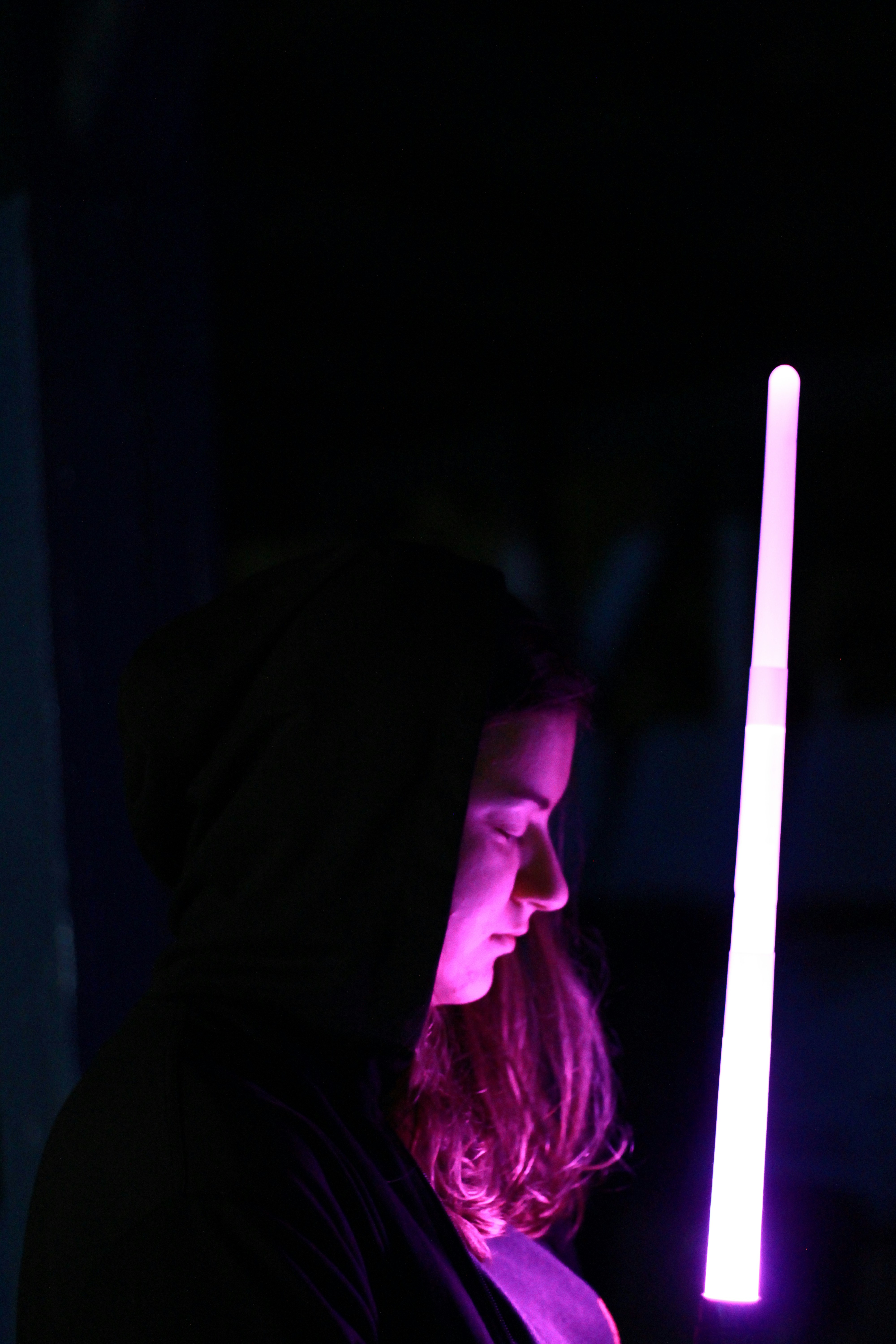 Hooded Profile Bathed in Magenta Neon Light