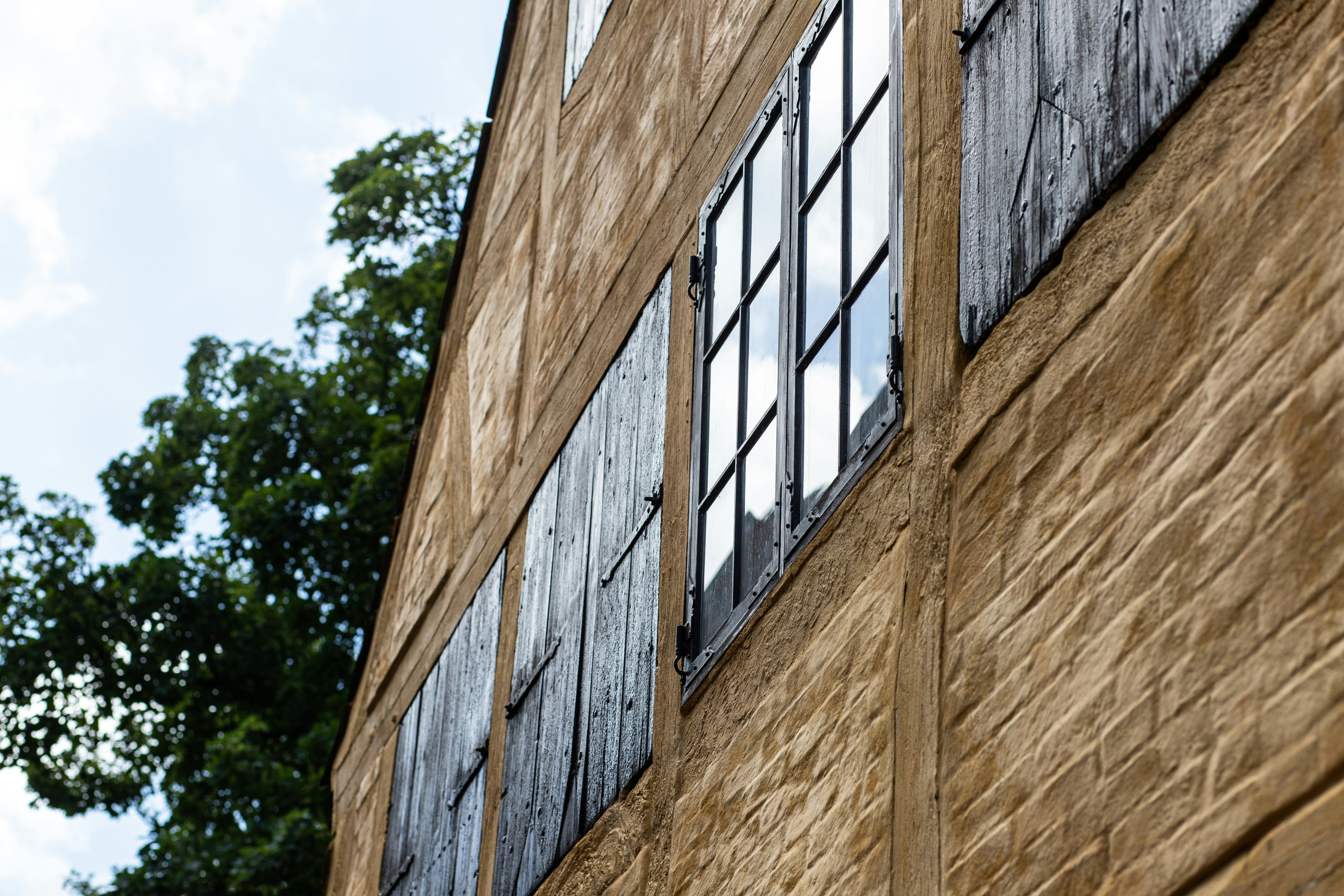 From a walk through Odense, Denmark | A building's exterior features windows and shutters.