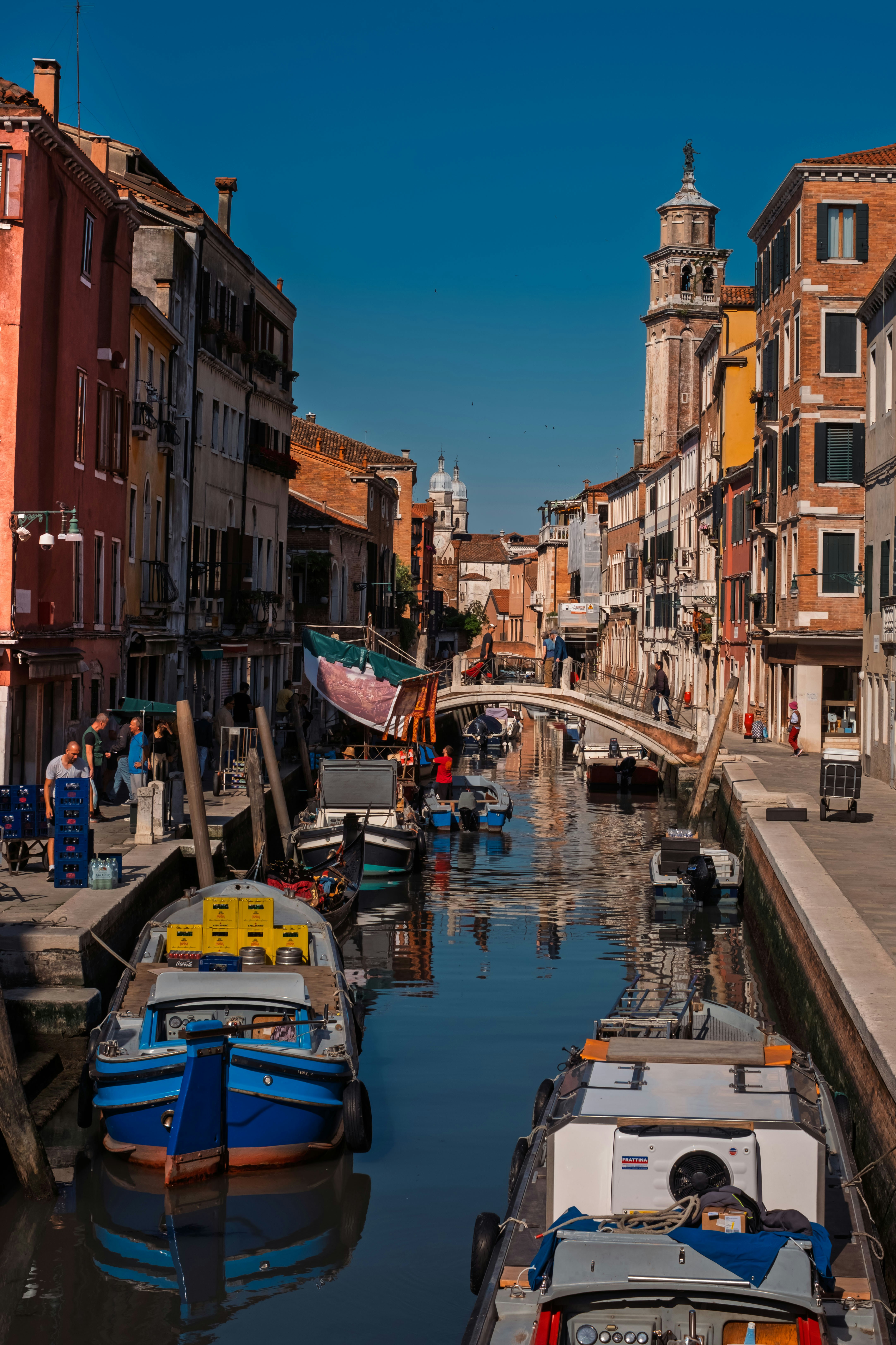 venice will always be iconic for its busy streets and canals, good food and rich history | Boats and buildings line a picturesque venetian canal.