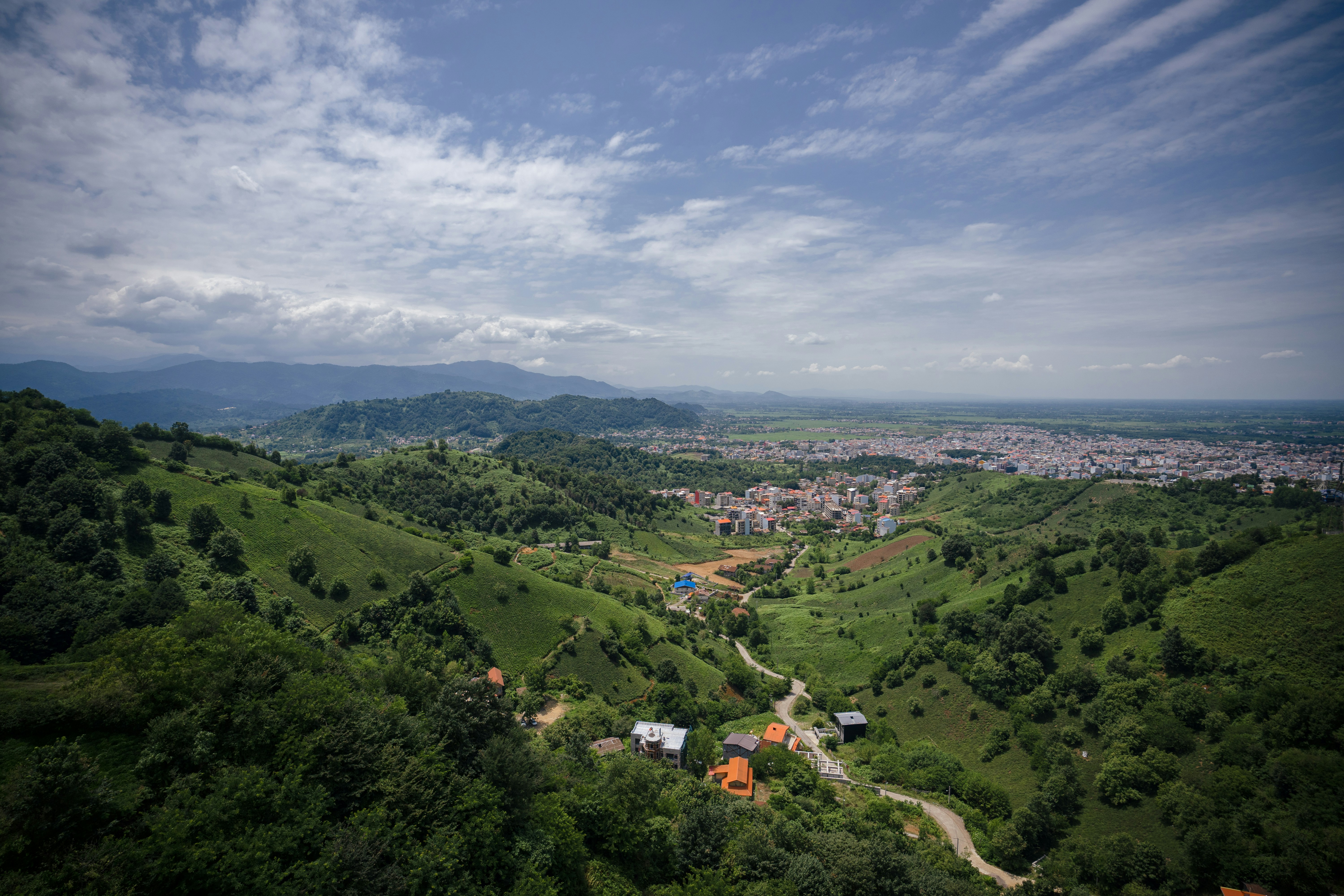 Hilly landscape features a distant town. photo – Free Wallpaper 4k ...