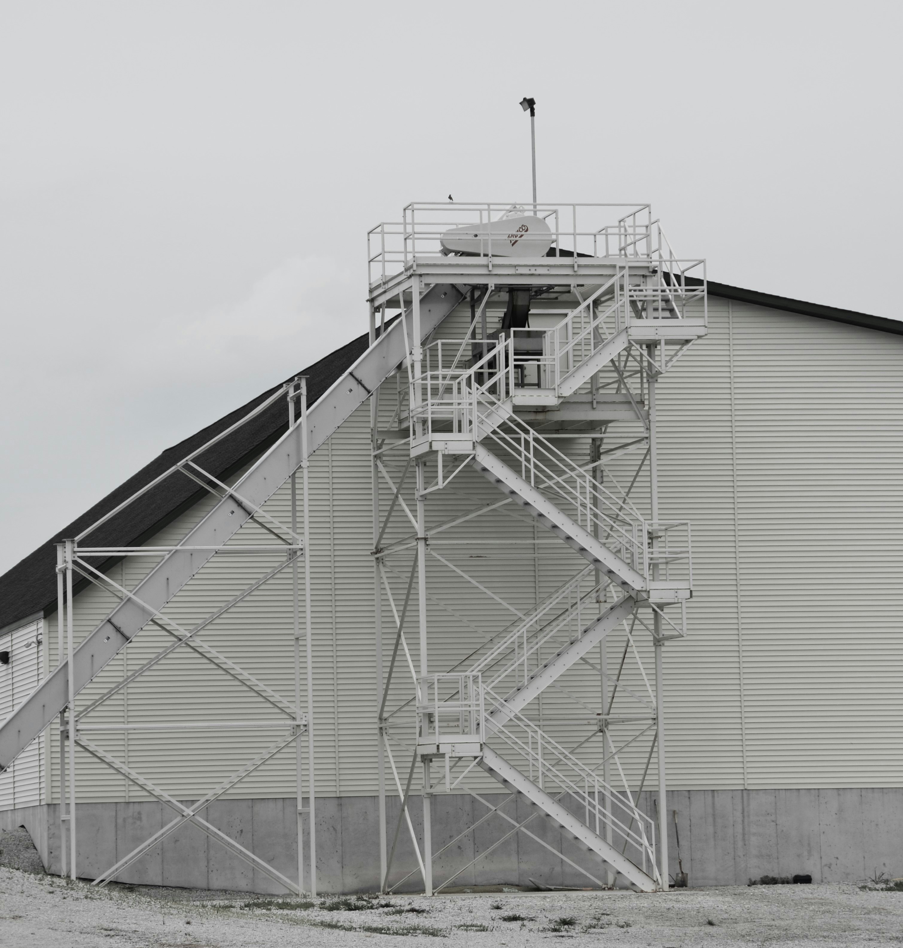 Industrial Heights: A Staircase to the Sky on a Steel Facade