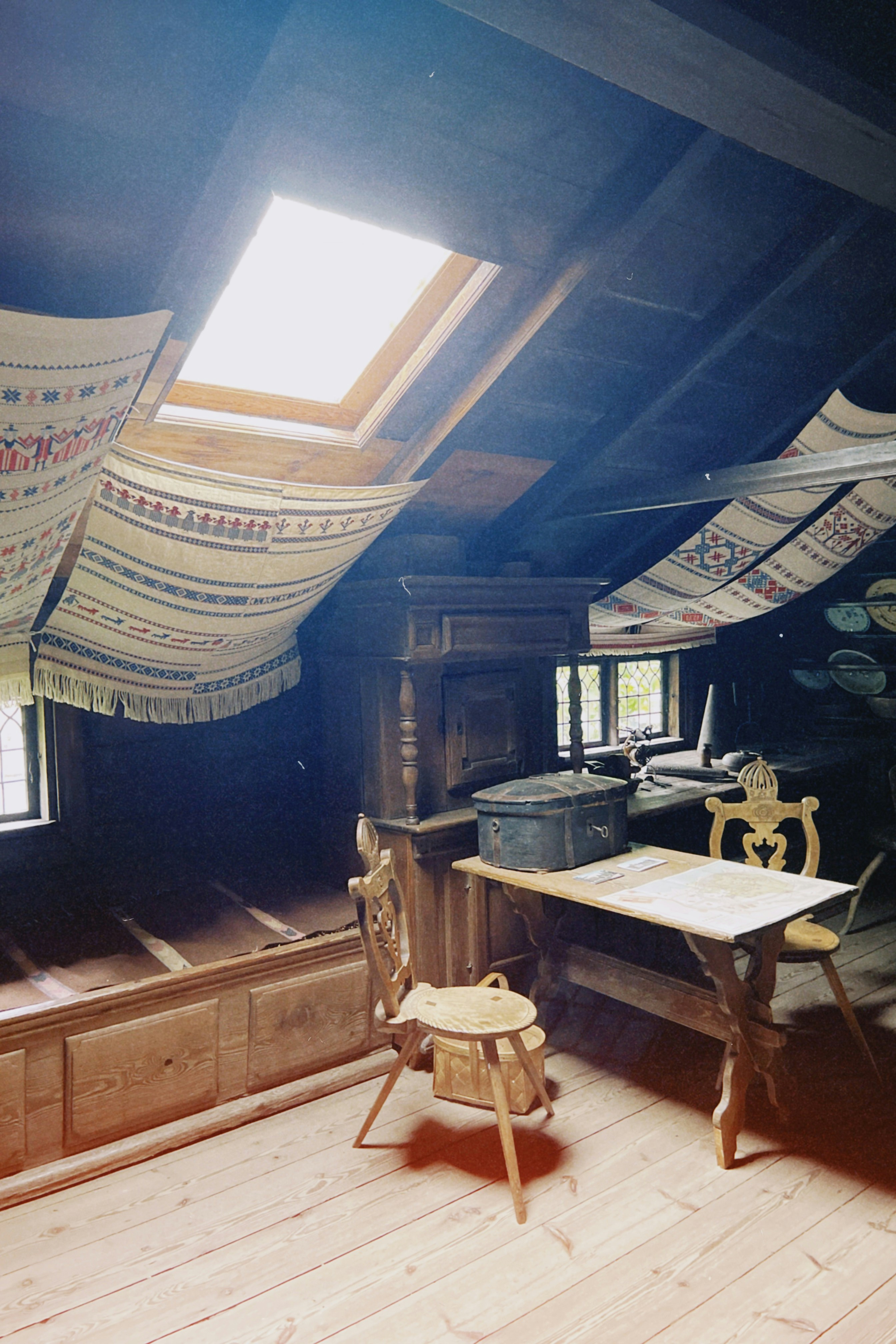 Skylight Nook: A Vintage Attic Desk Surrounded by Woven Drapes