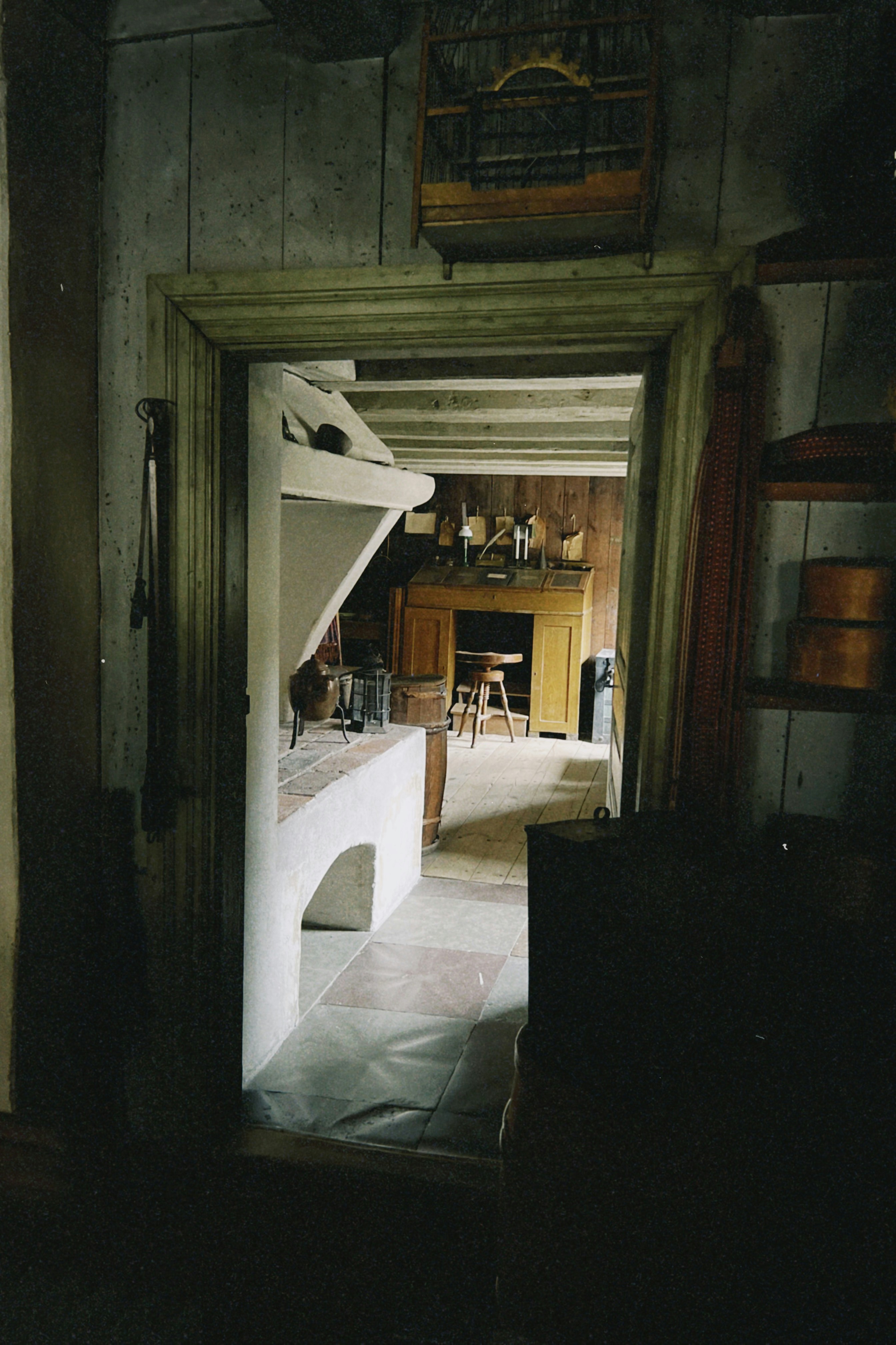 An old interior, showing through a doorway.