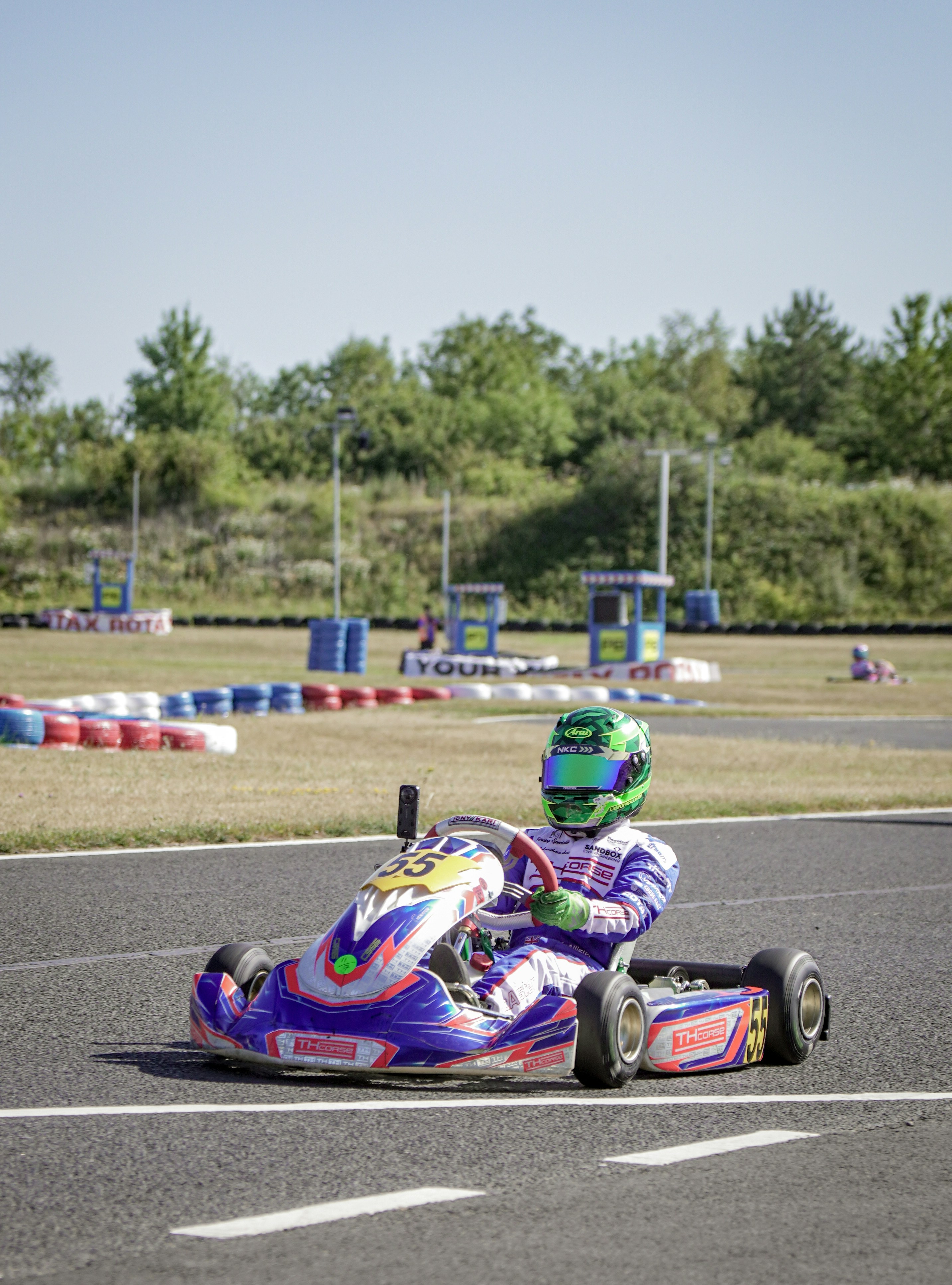 Neon-Green Racer Surges Across a Sunlit Go-Kart Circuit