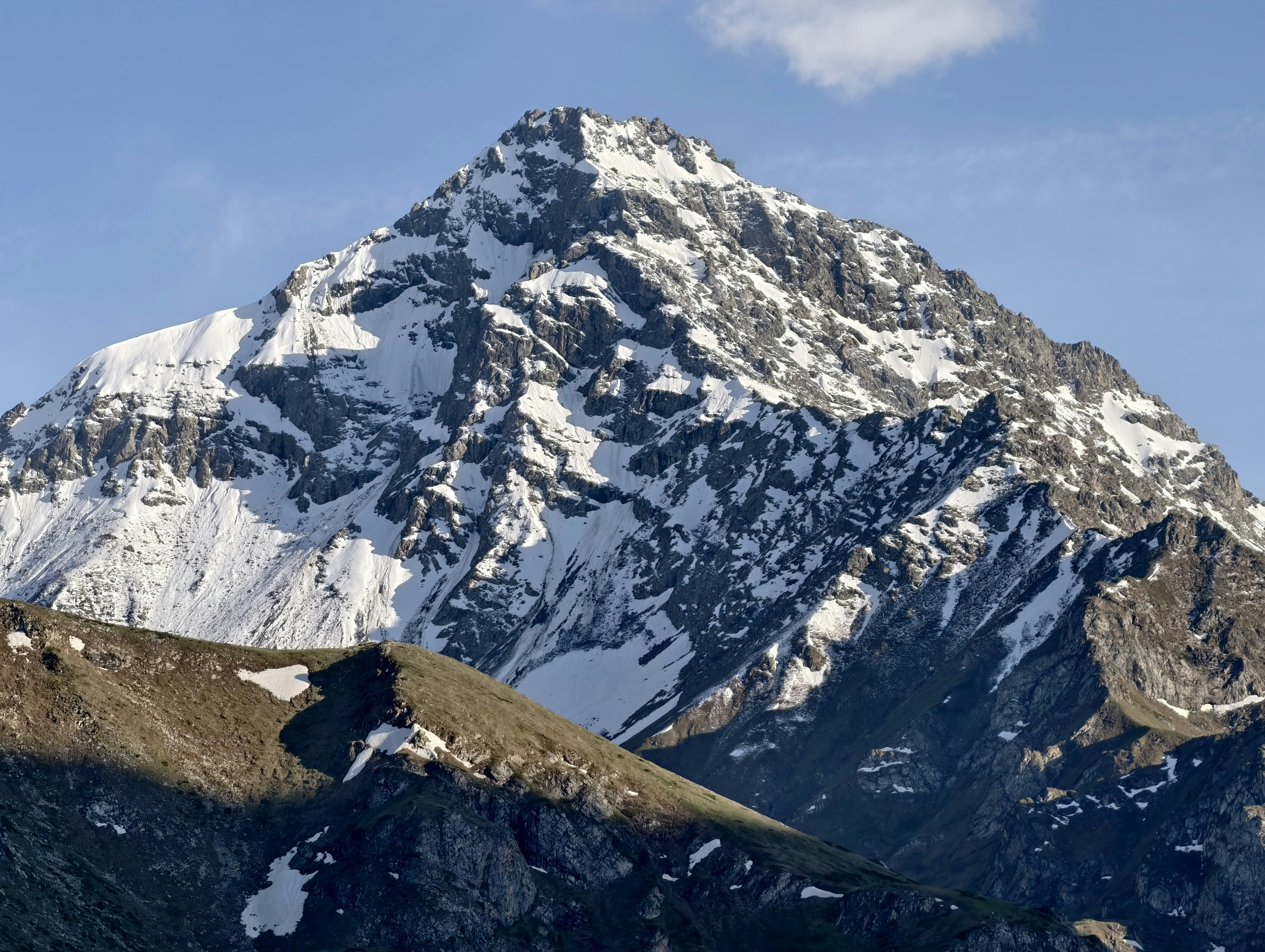 A snowy mountain peak reaching upward.