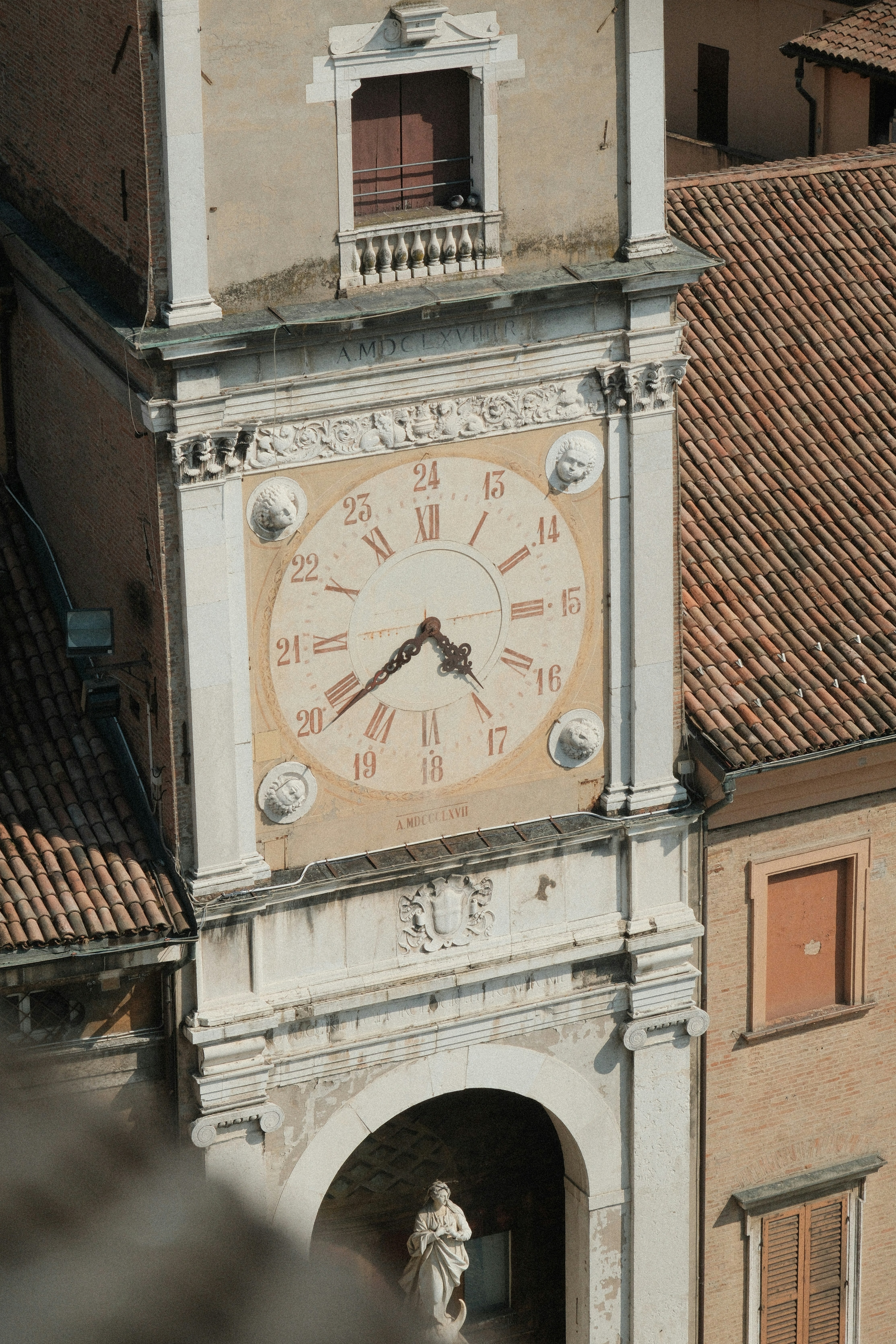 A clock tower features ornate architecture and a sculpture.