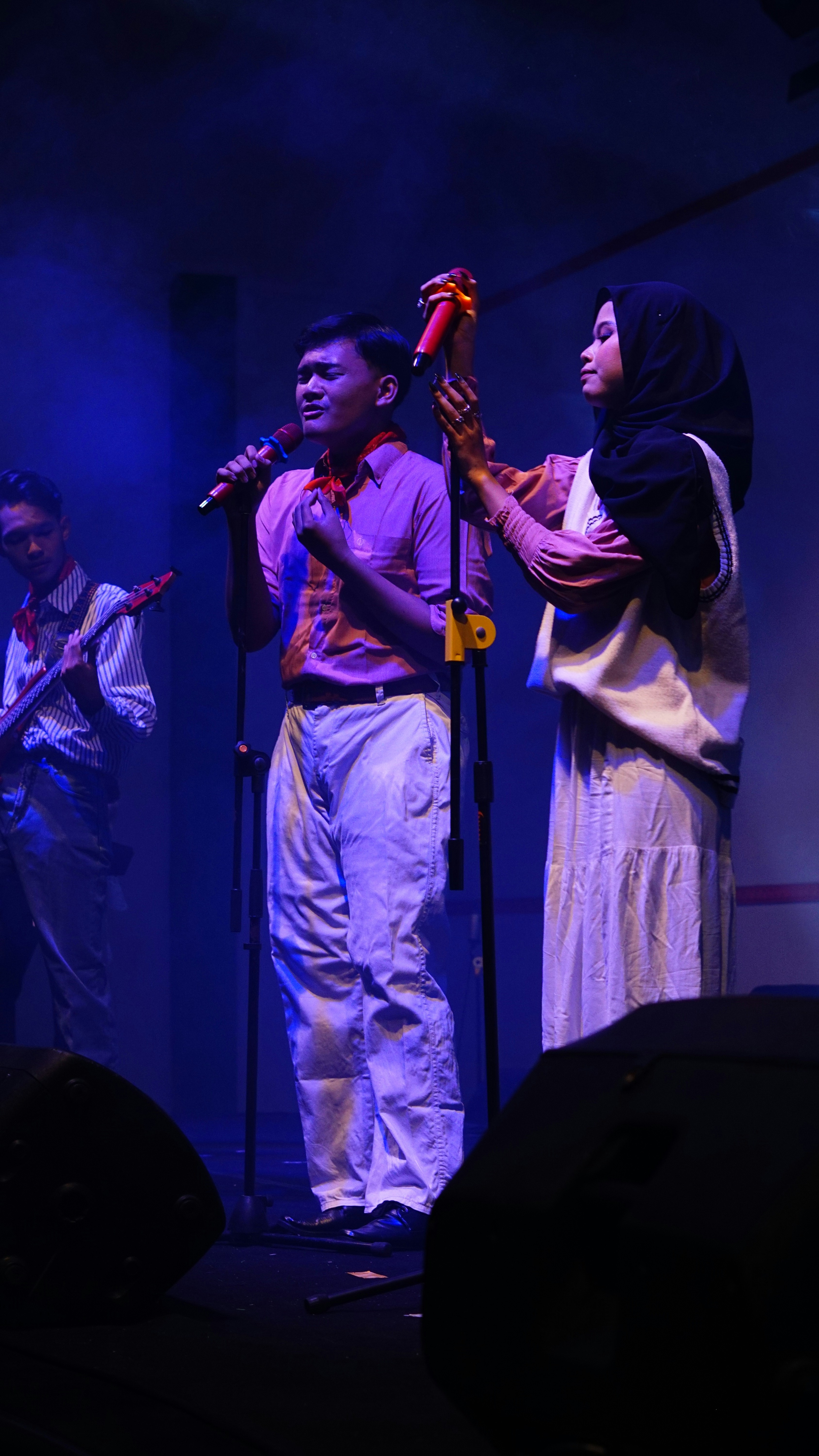 A band performs on stage with a vocalist.