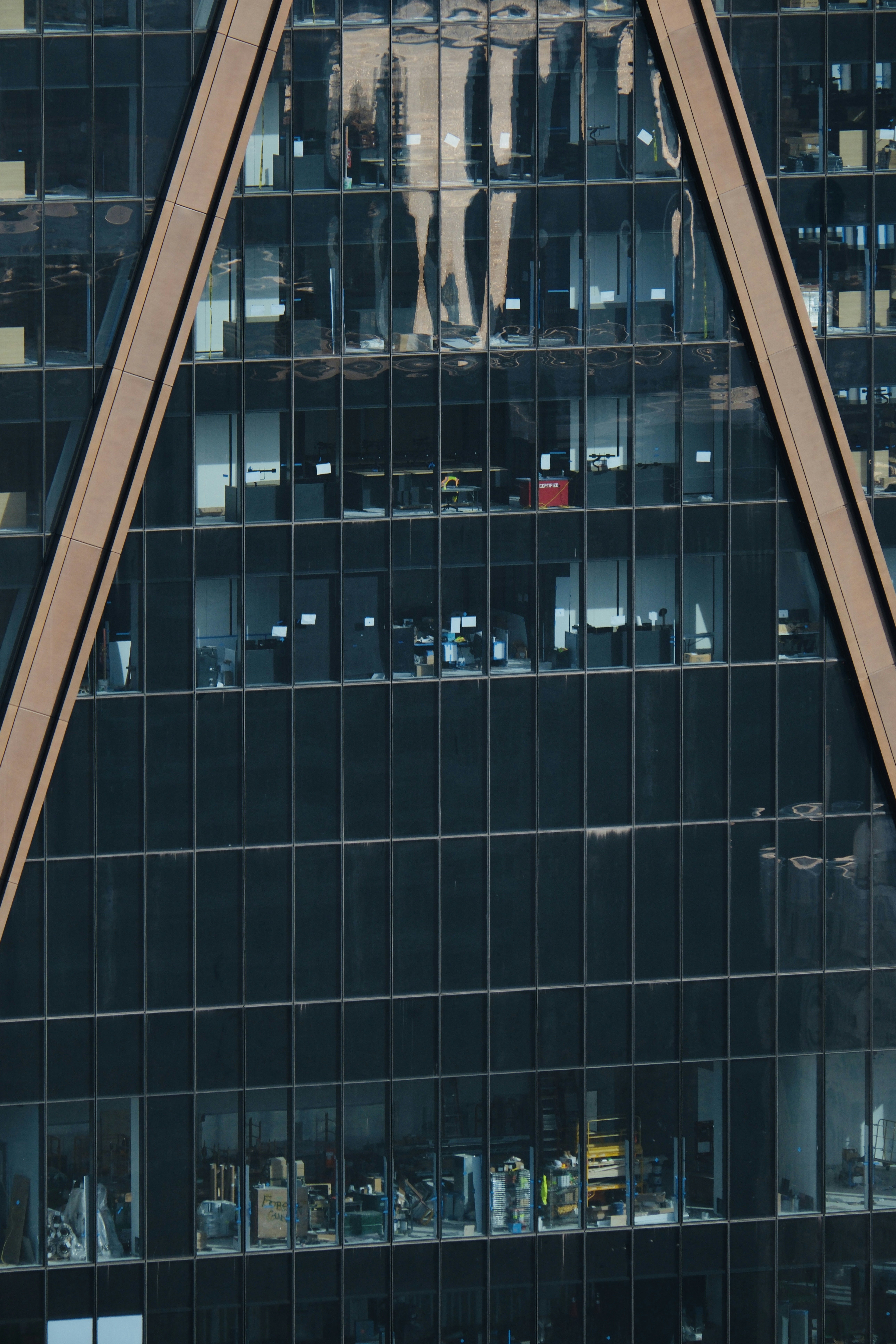 Diagonal Steel Arches Framing a Glass-clad Facade