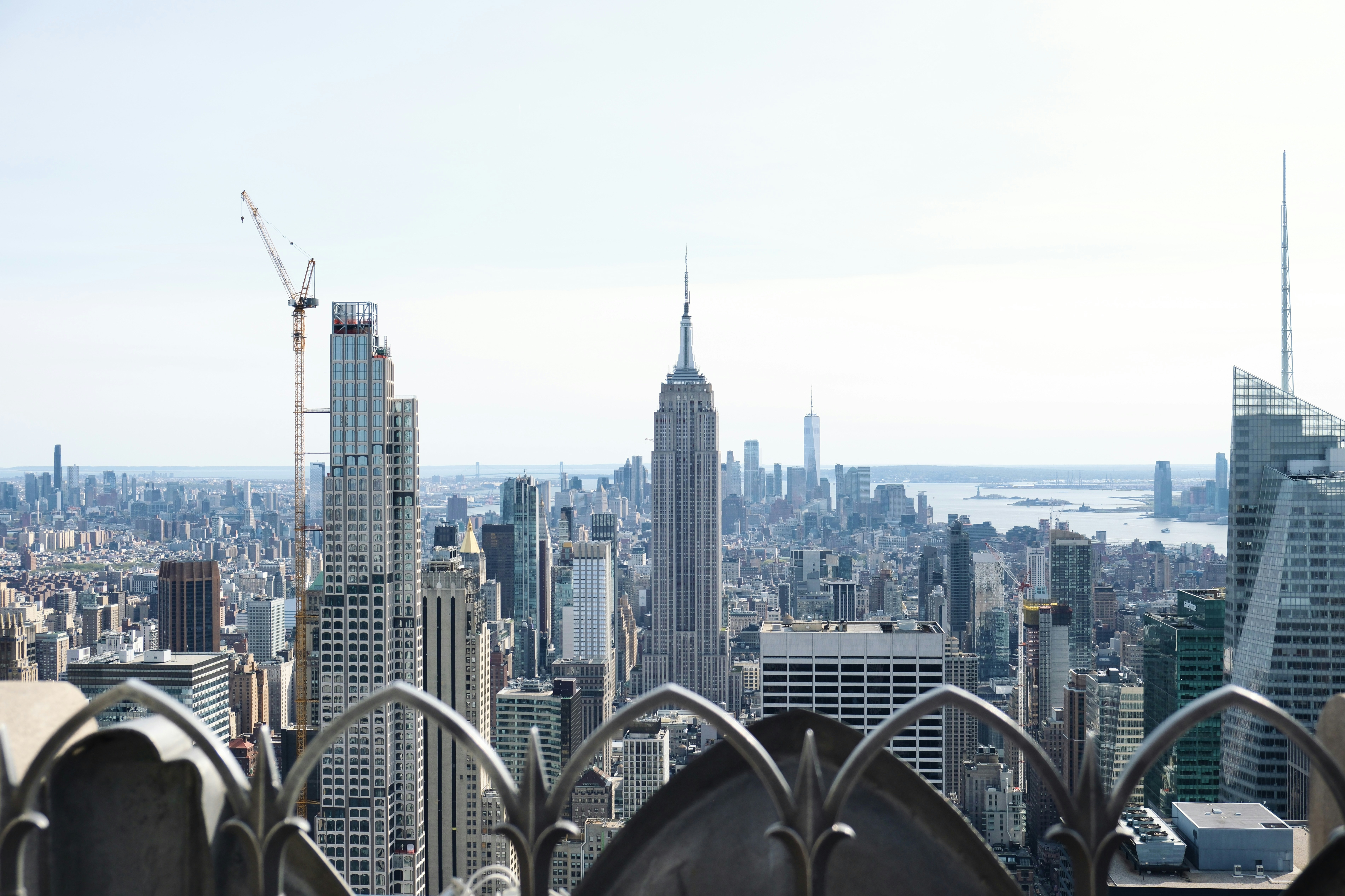 Rooftop View: City Spire Surrounded by Steel Silhouettes