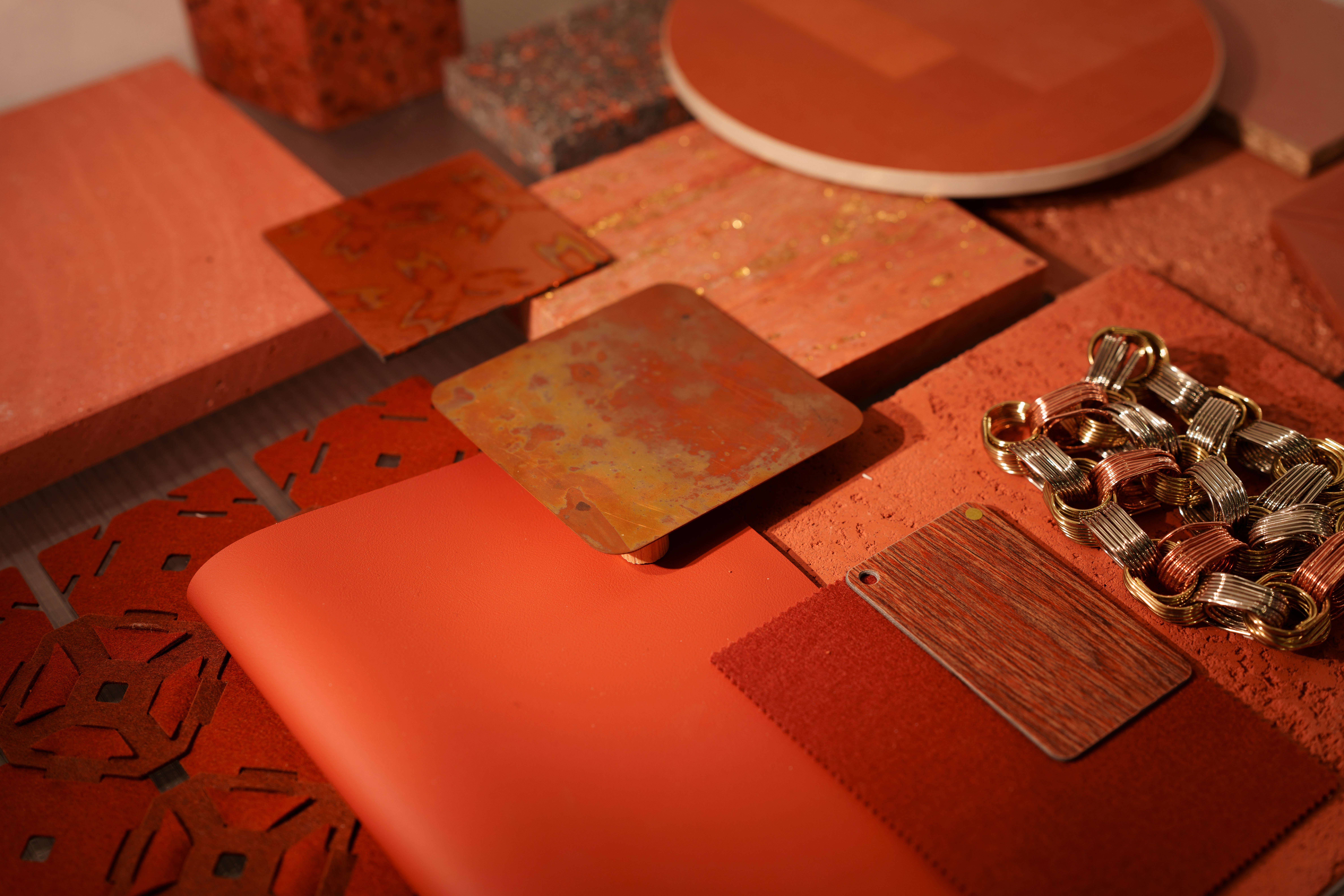 A collection of terracotta-toned materials showcasing various textures and finishes, ideal for design inspiration.