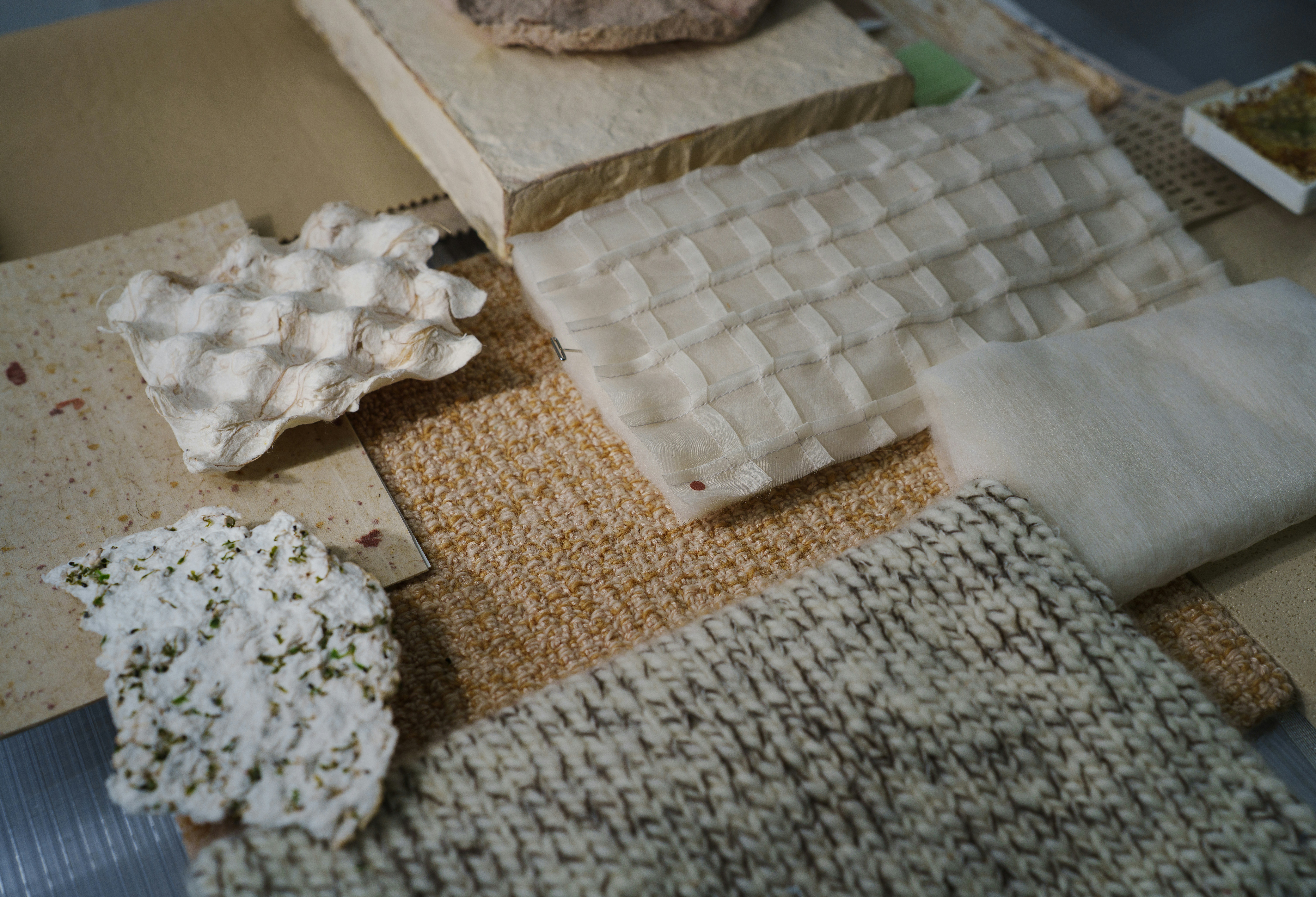 An array of various textured materials, including woven fabrics and natural elements, arranged for tactile exploration.