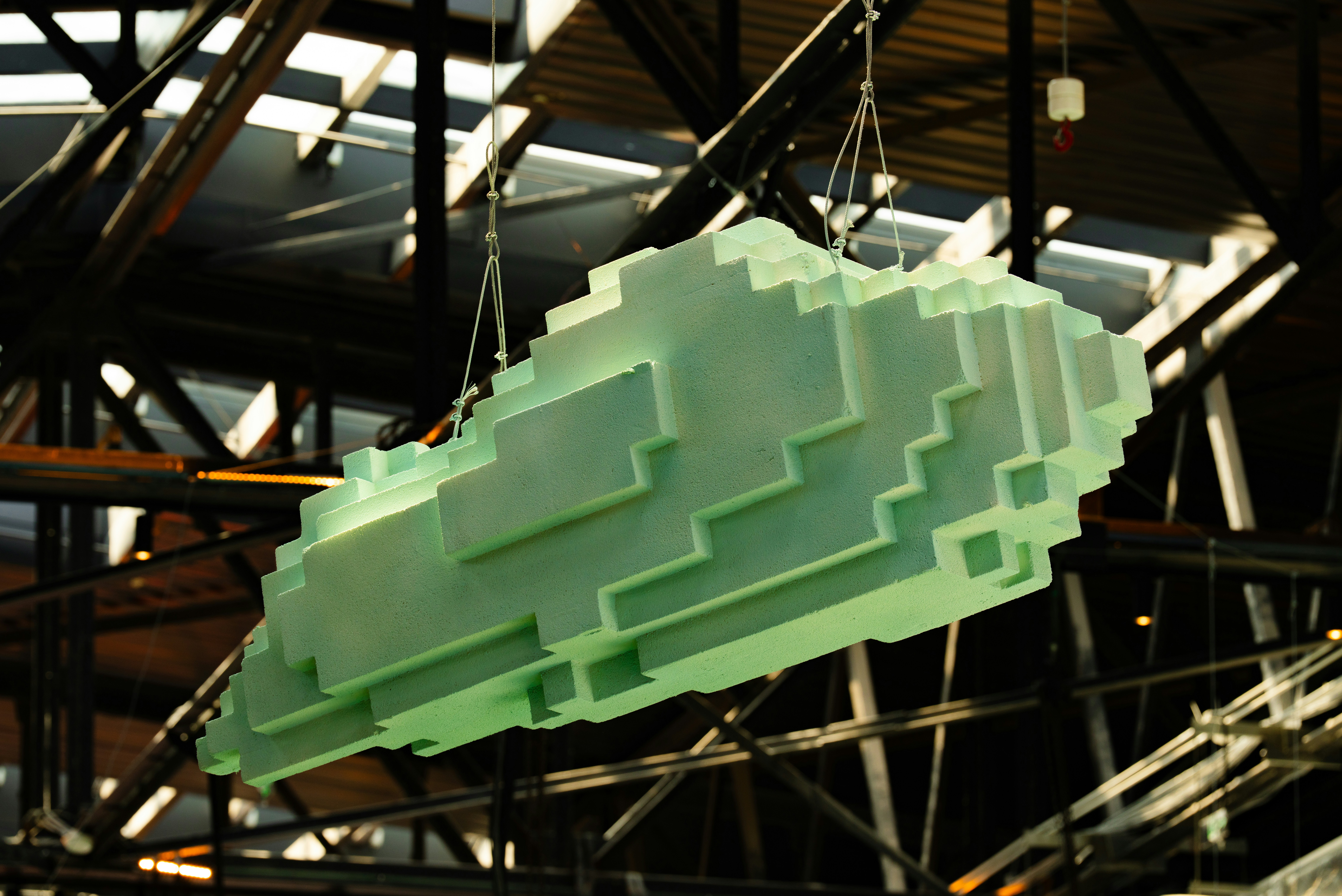 Mint Pixel Cloud: a suspended geometric sculpture in an industrial loft