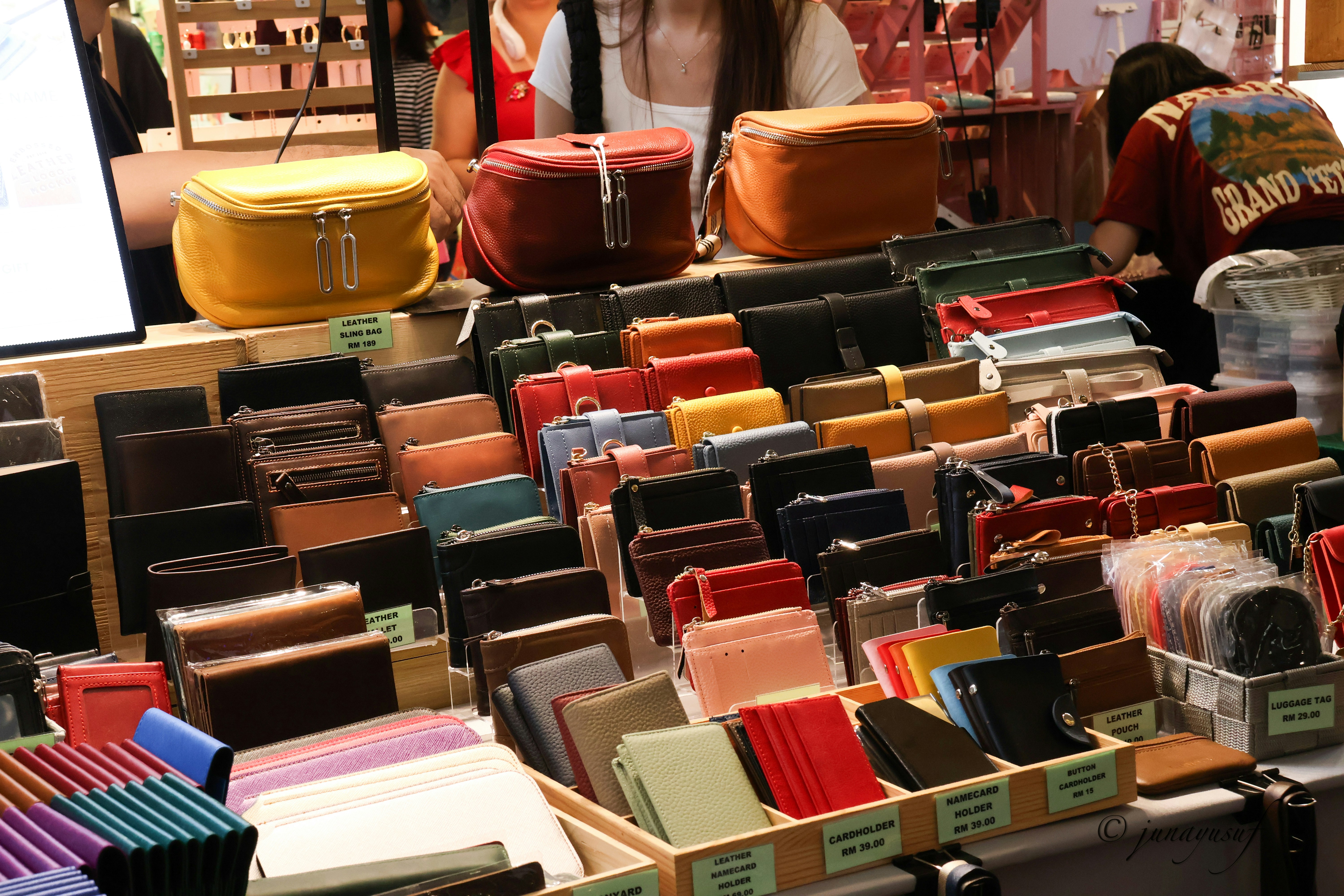 Here's a caption for the image: a wide array of colorful purses and ...