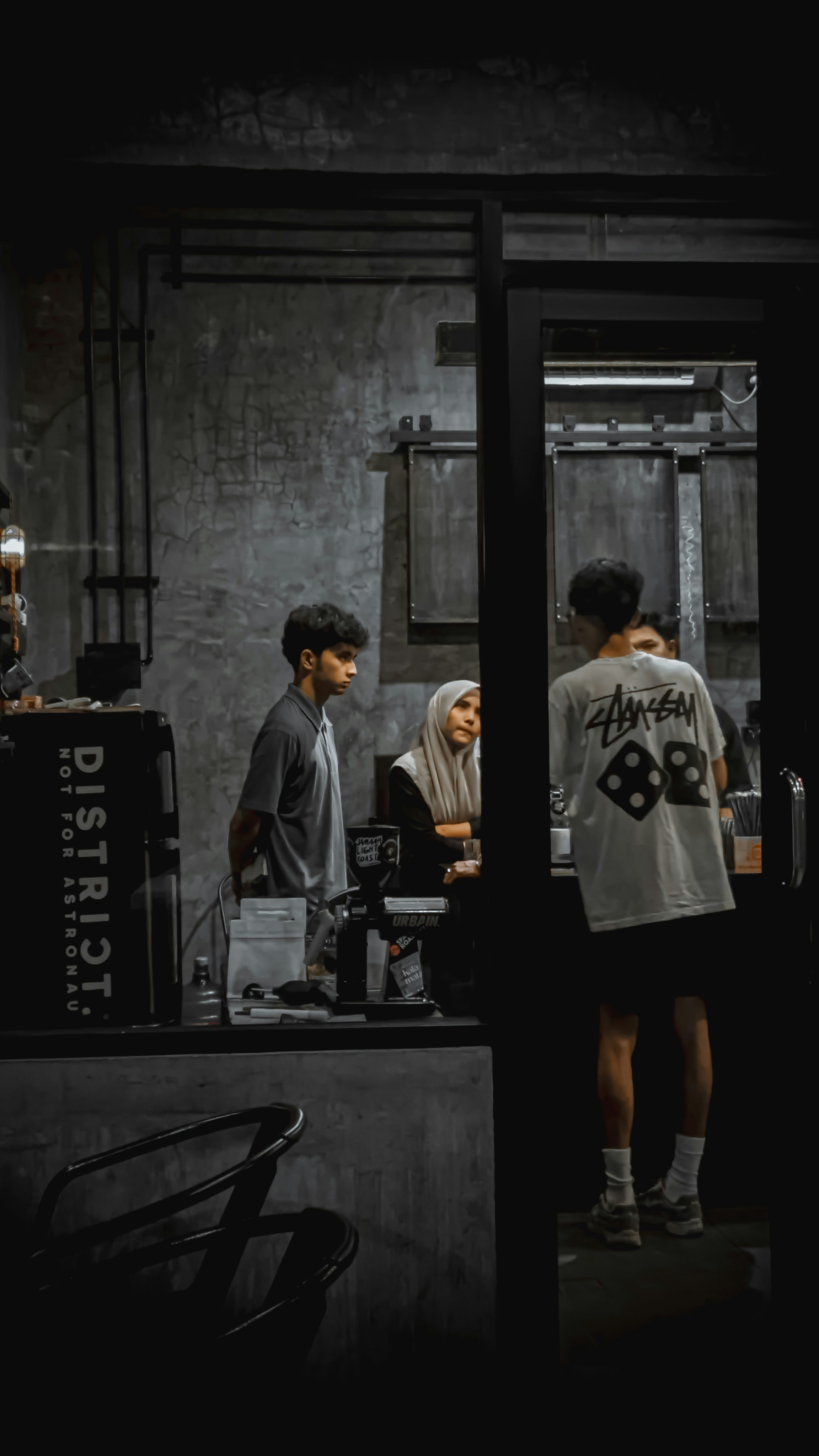 Coffee shop team discussion | People are at a coffee shop counter.