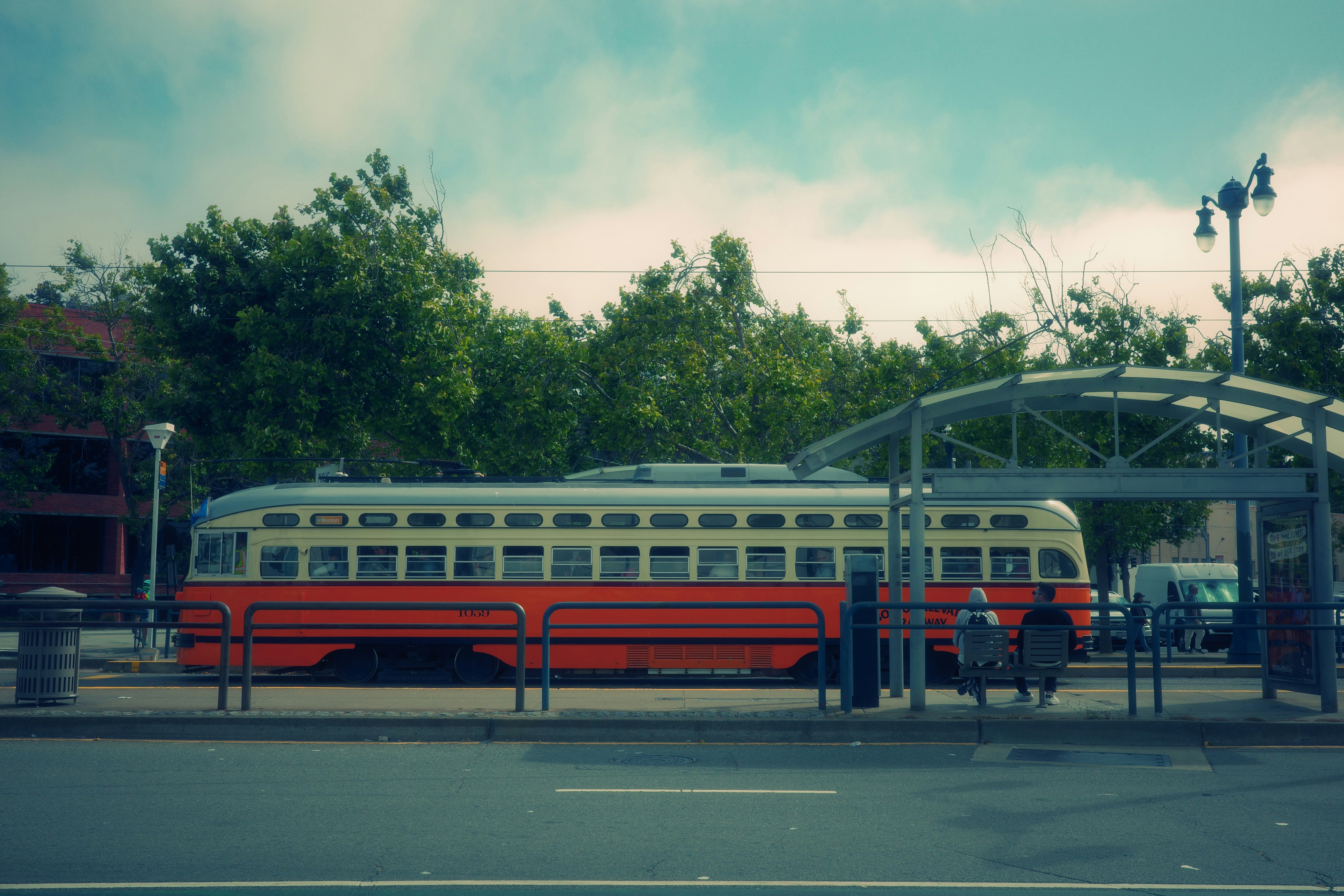 An old-fashioned trolley waits at a bus stop. photo – Free Usa Image on ...