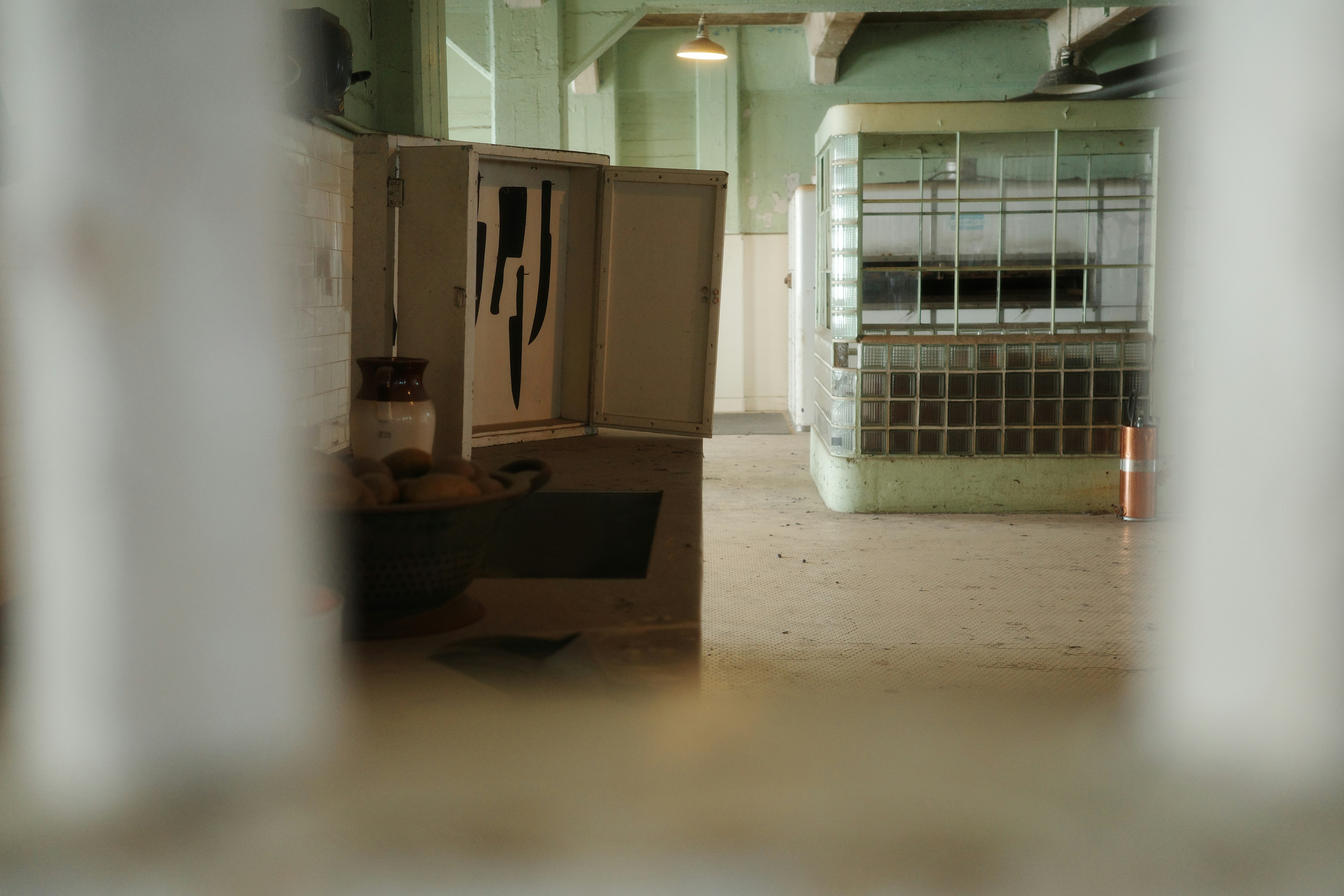 Echoes Through a Green-Washed Corridor: The Lone Cone in a Dim Warehouse