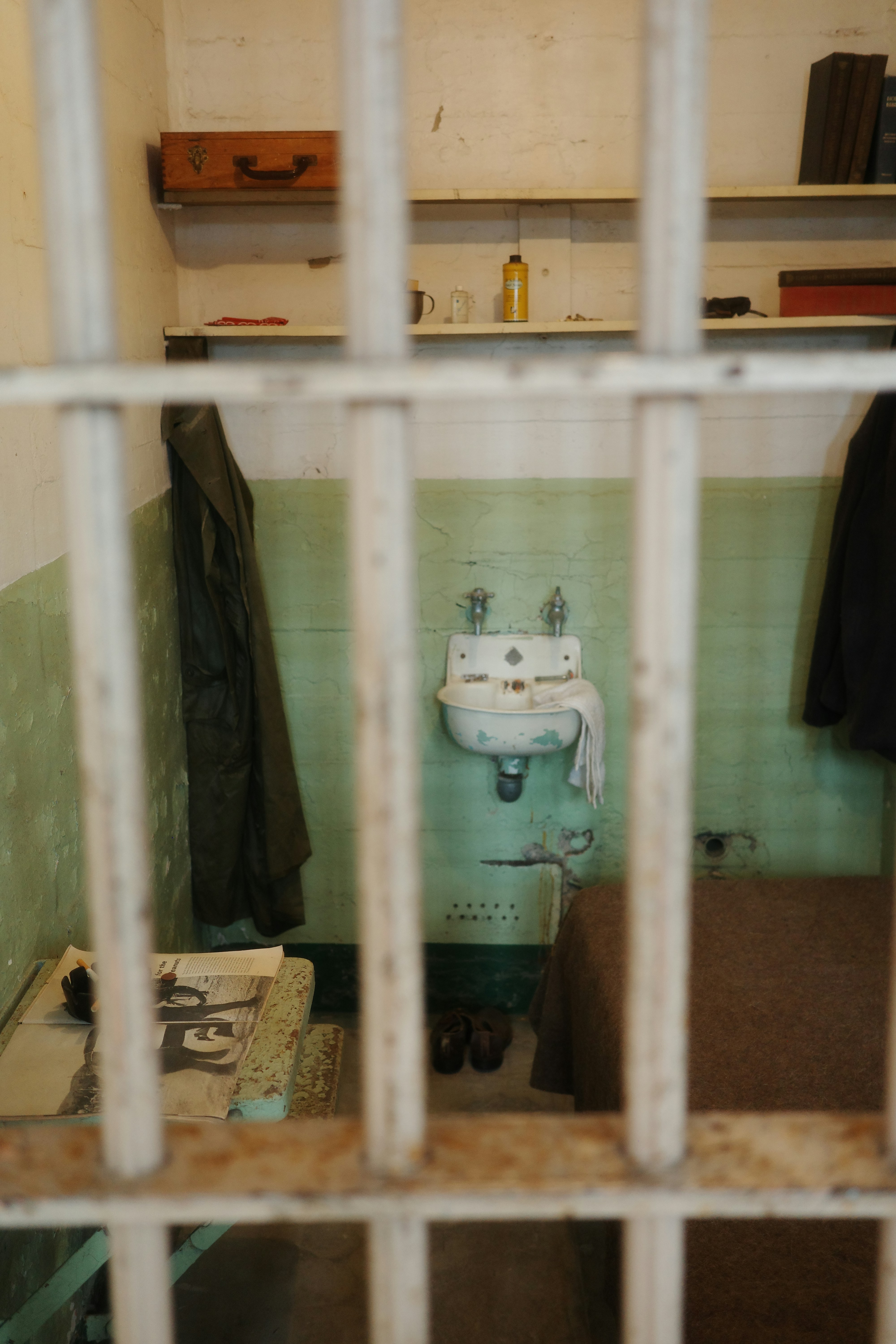 Prison cell interior is viewed through jail bars. photo – Free Usa ...
