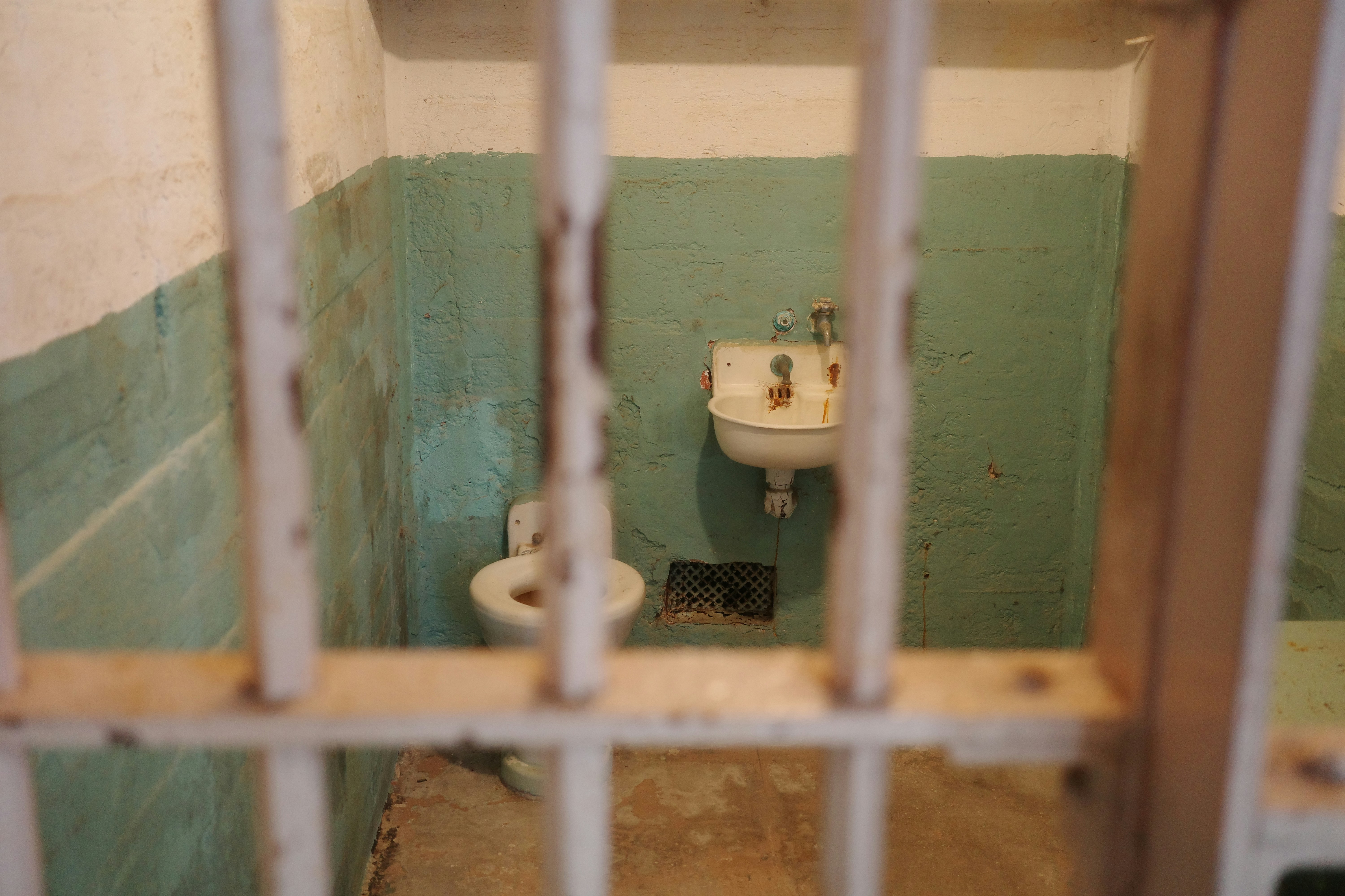 Behind bars: a prison cell with a toilet.