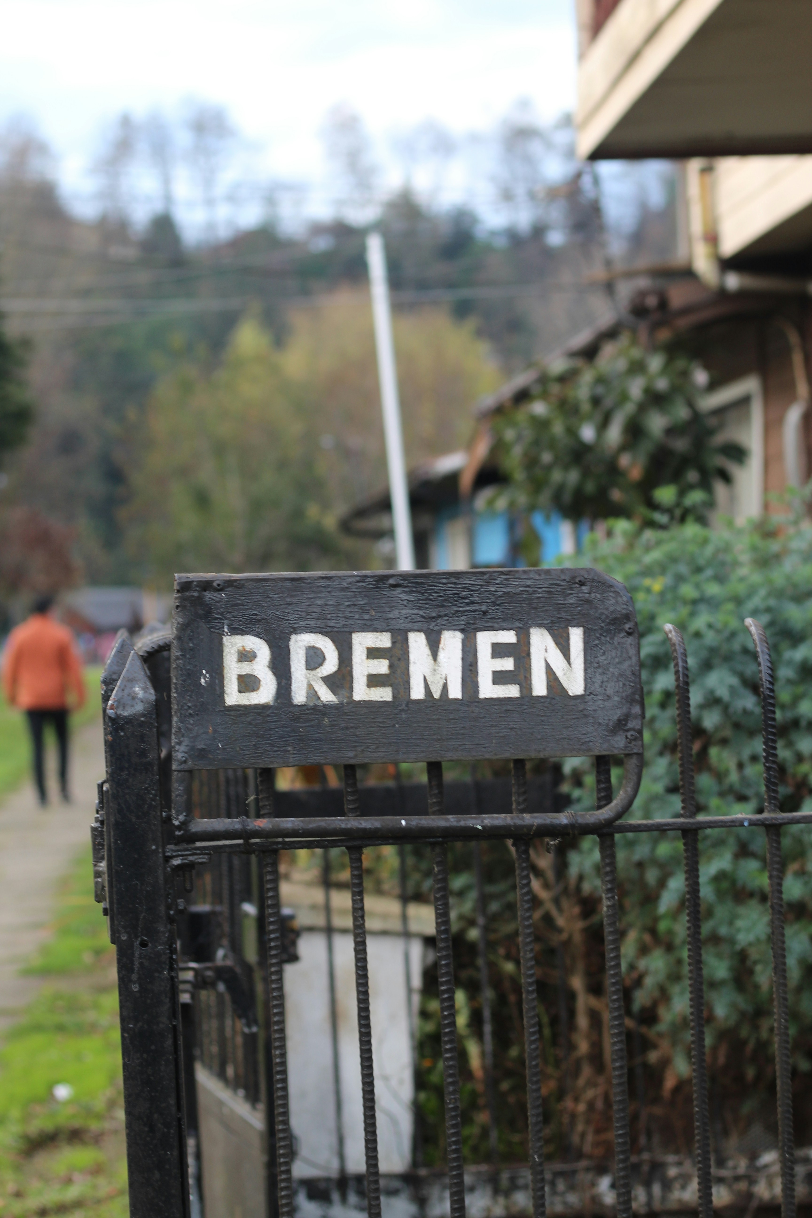 Bremen Gate in Focus: A Quiet Rural Path Framing an Orange Figure