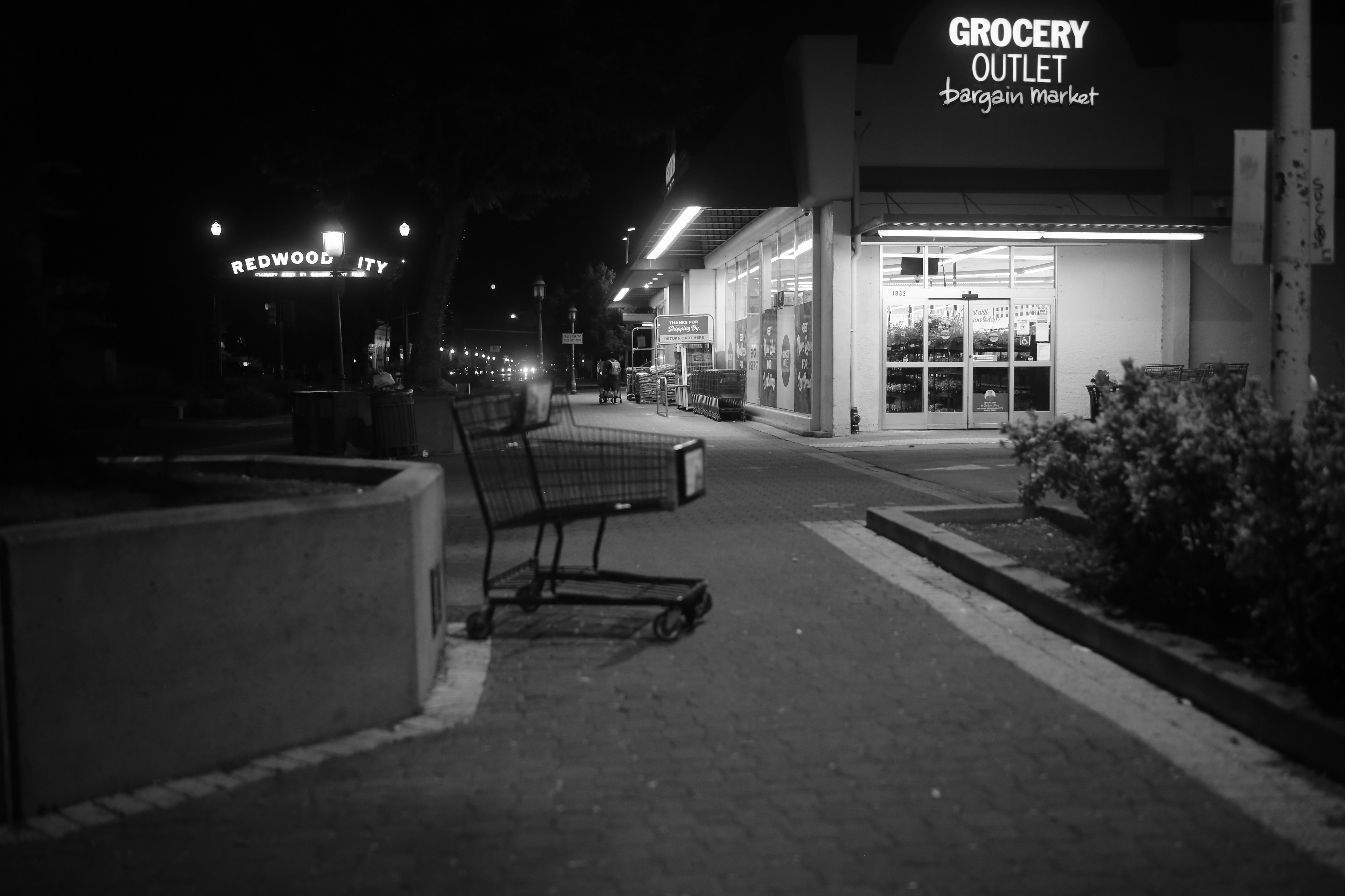 A grocery store entrance at night.