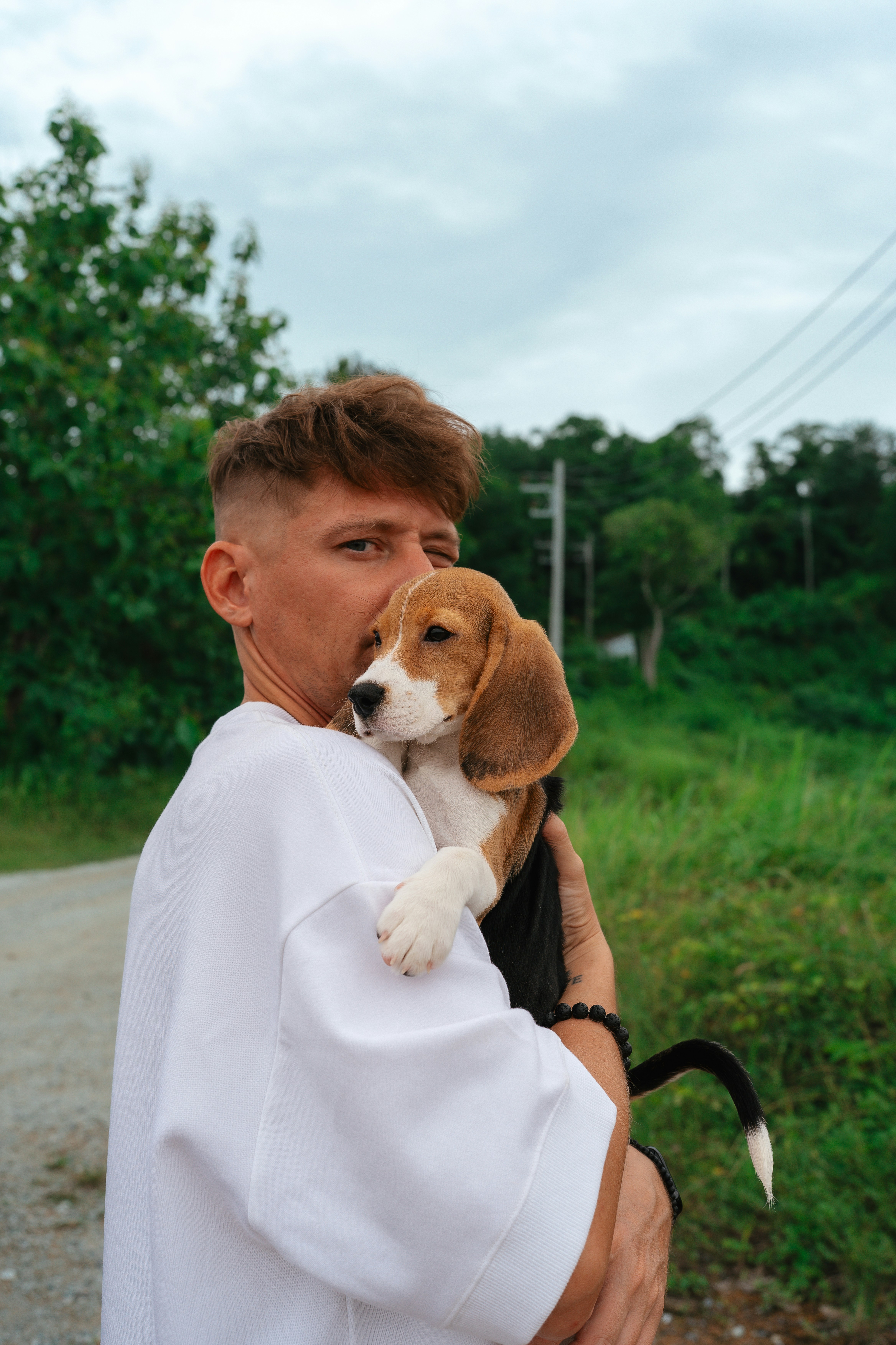 On a Quiet Rural Road, a Man and Beagle Share a Tender Moment