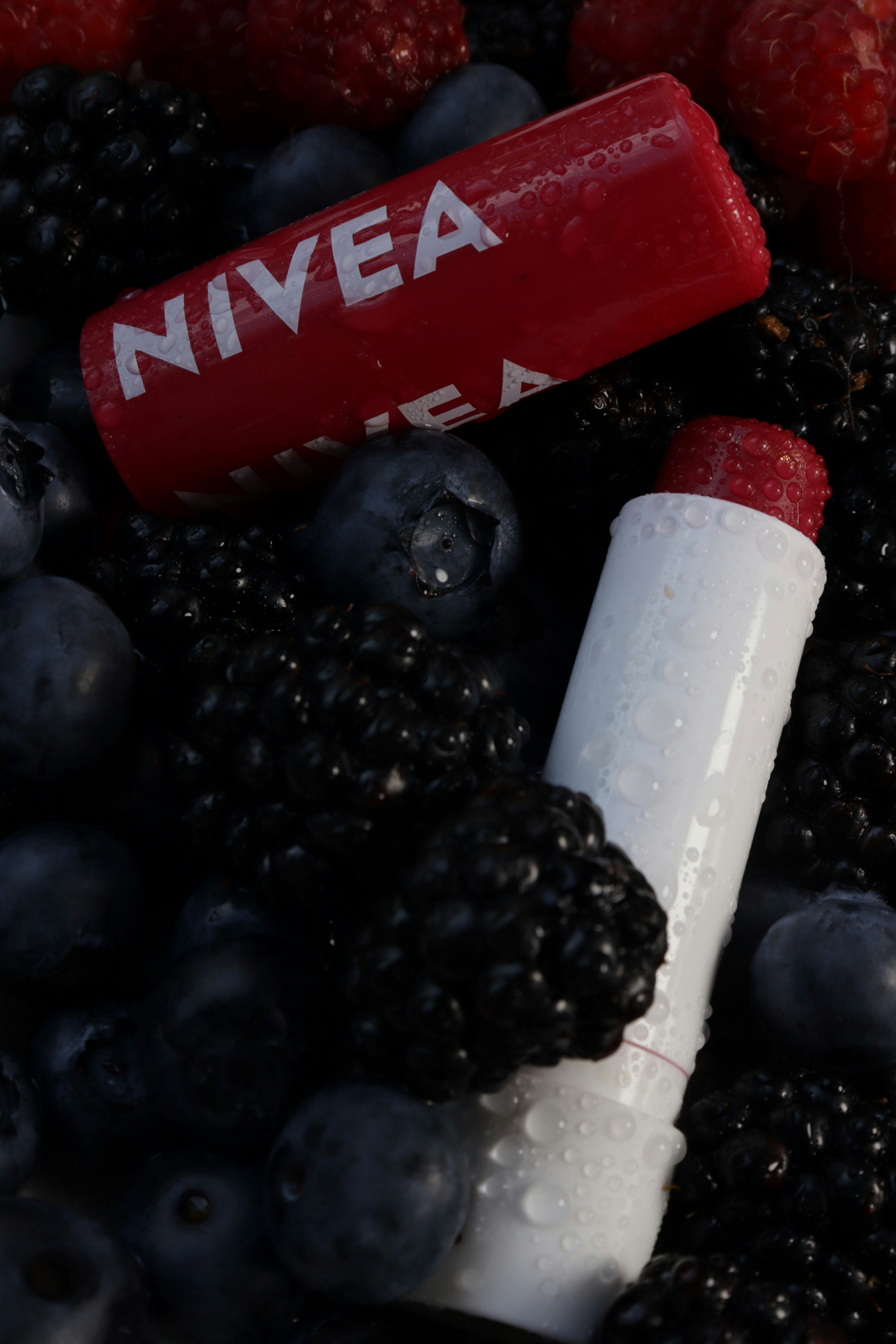 Nivea lip balm surrounded by berries.
