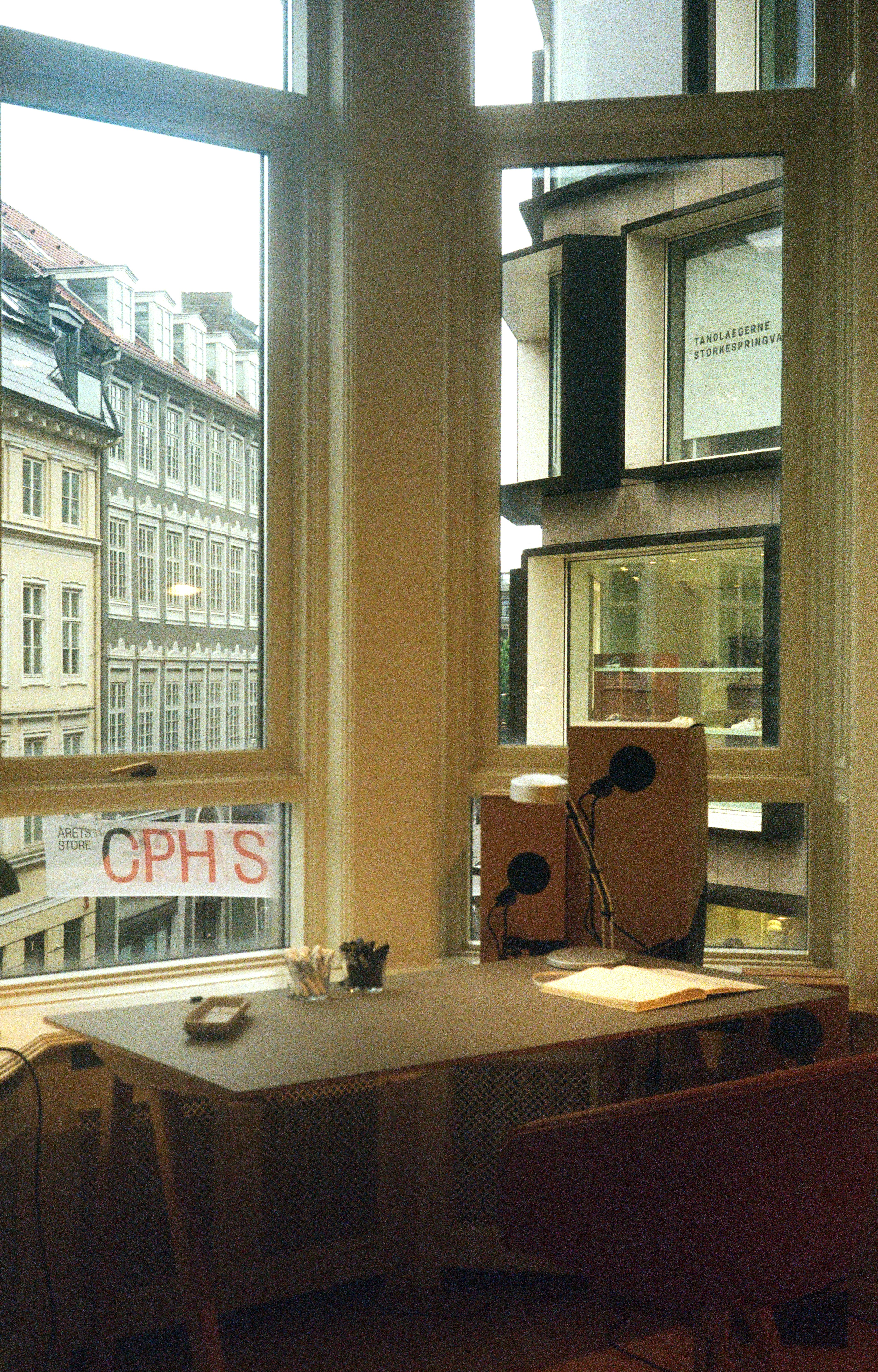 A desk sits beside a window overlooking a city. photo – Free Film ...