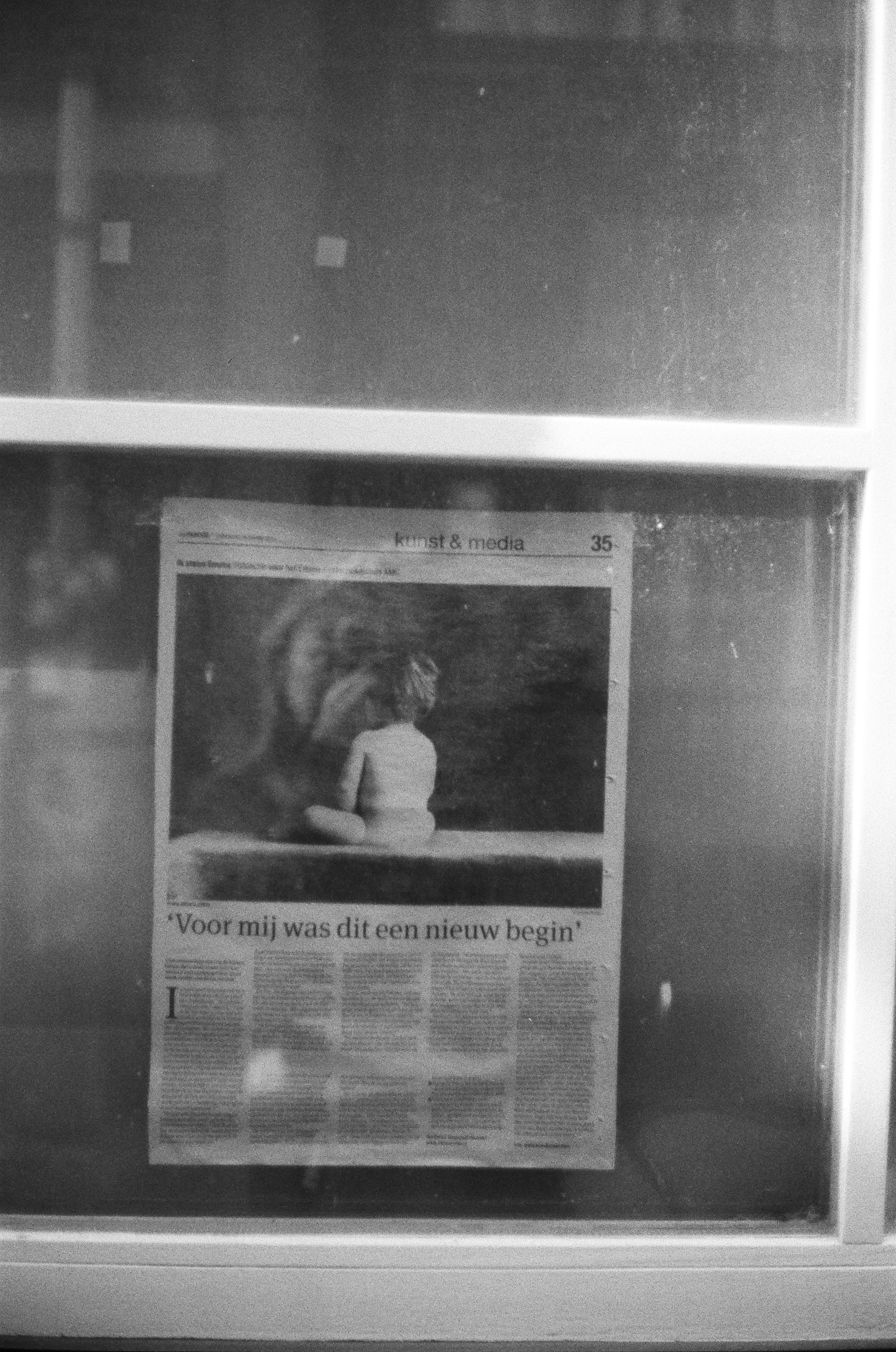 A newspaper with an image is behind glass. photo – Free Human Image on ...