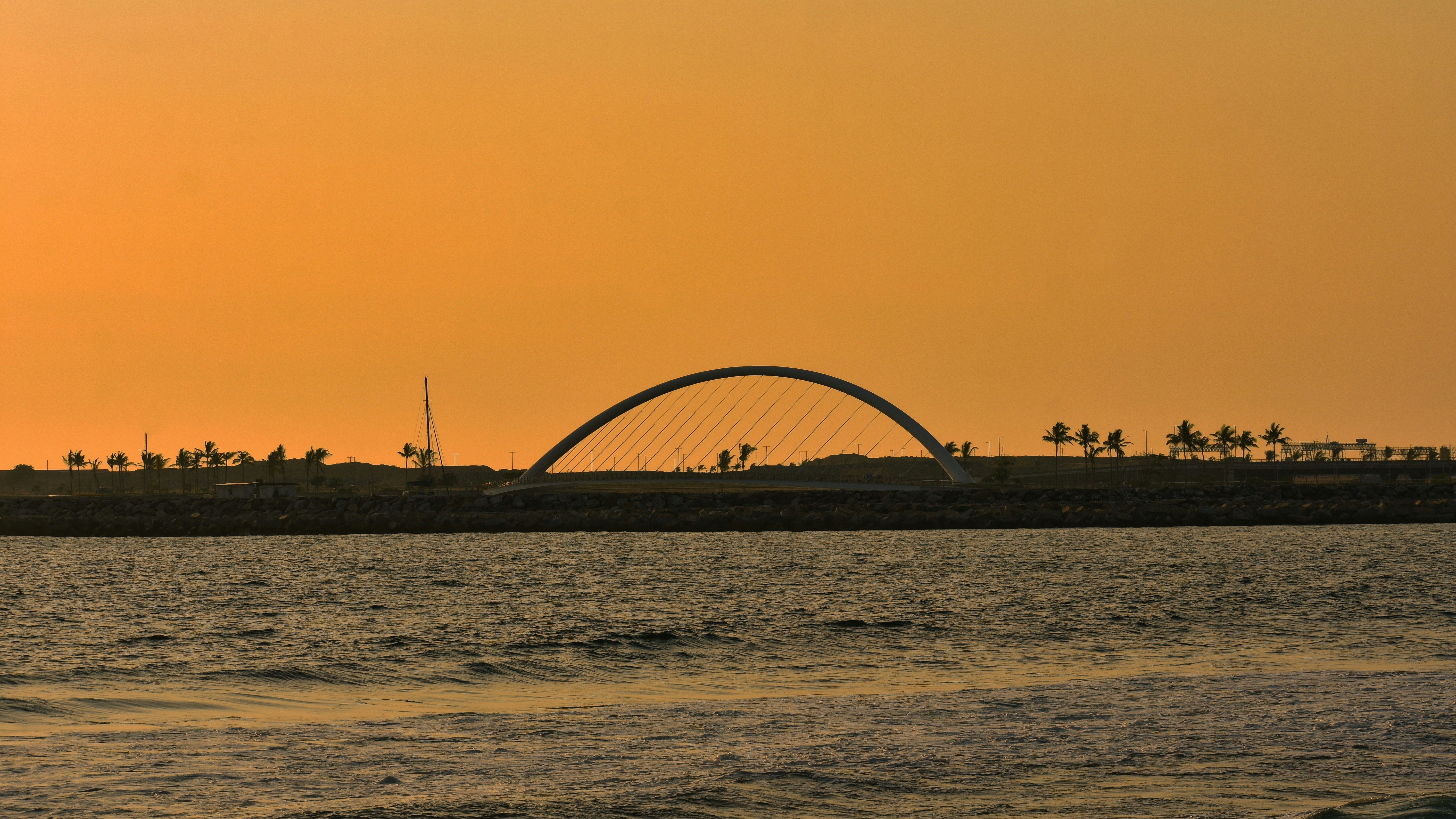 A bridge silhouetted during a sunset.