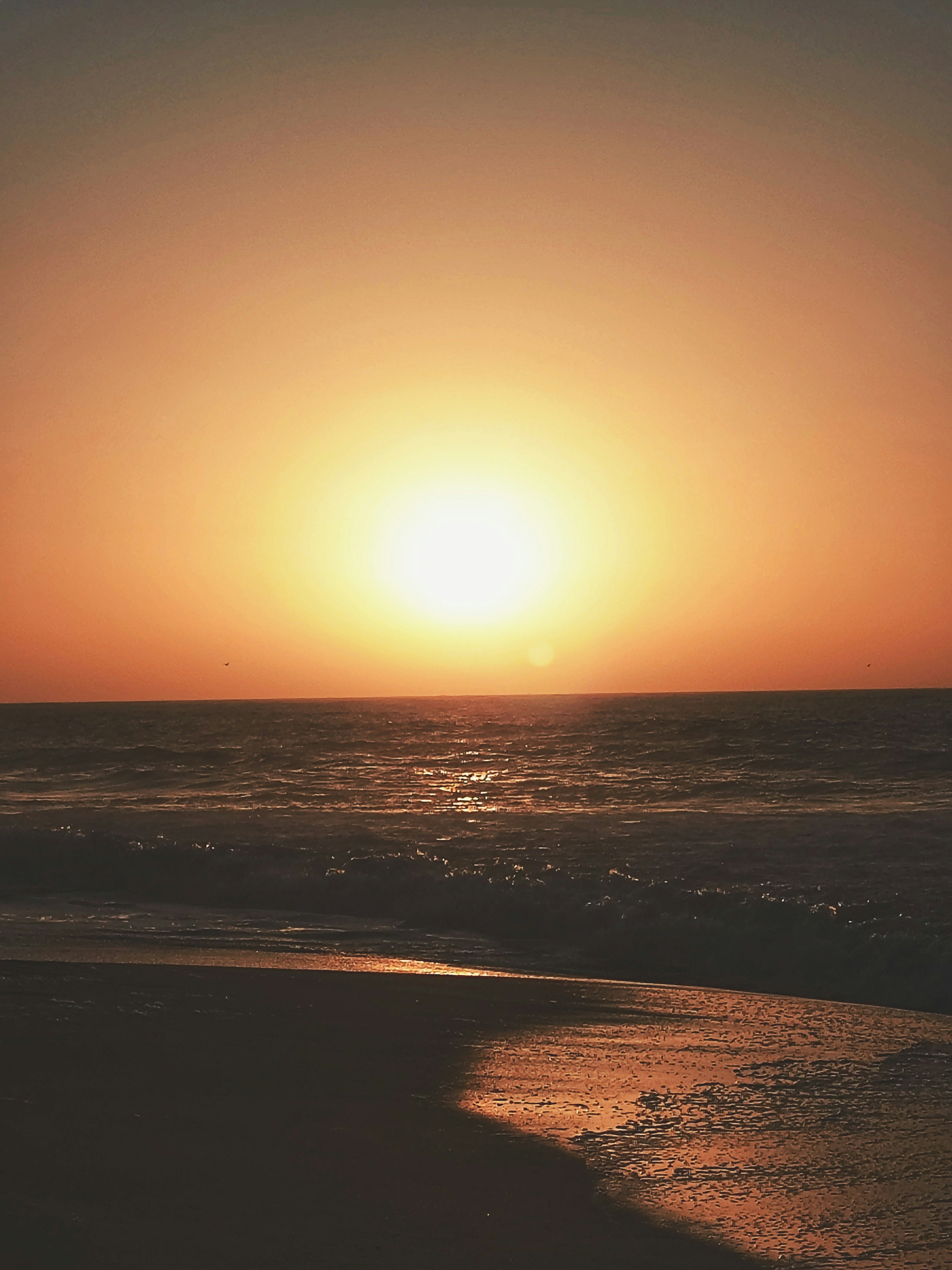 Sunset over the ocean, a beautiful scene.