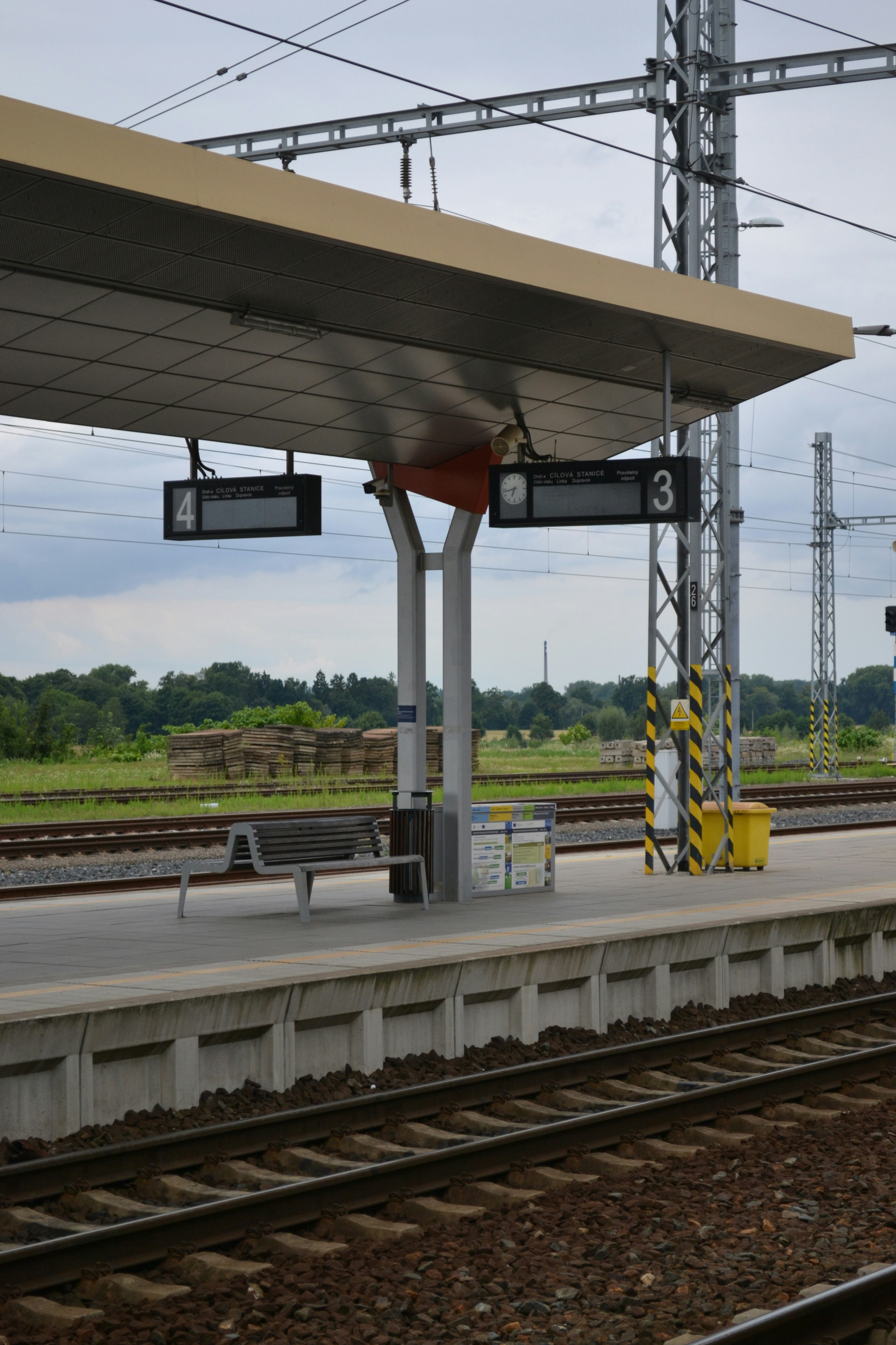 A railway platform shows waiting for trains.