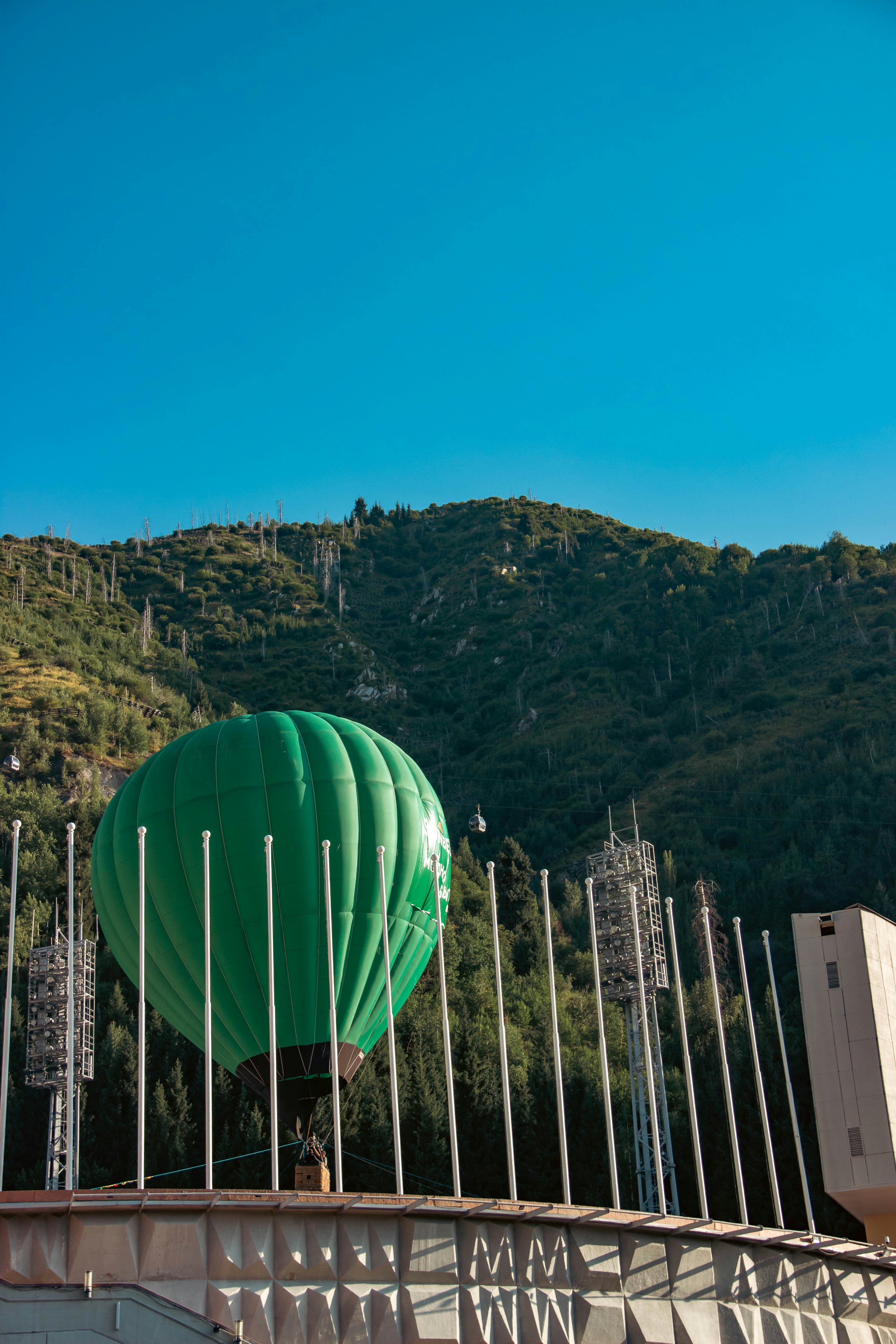 Emerald Ascent: A Balloon's Journey Above the Peaks