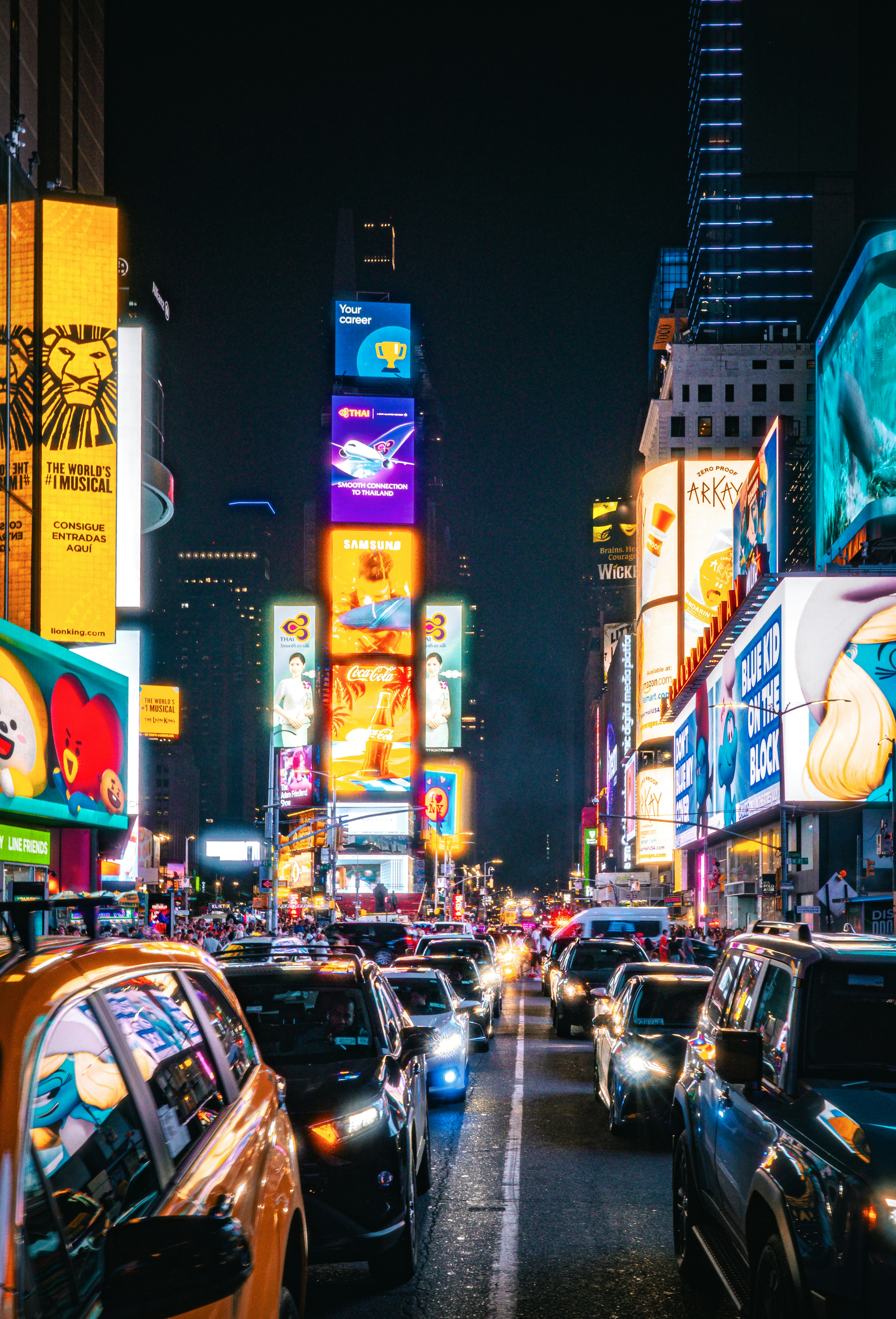 Times Square at night | Times square glitters with lights and traffic.
