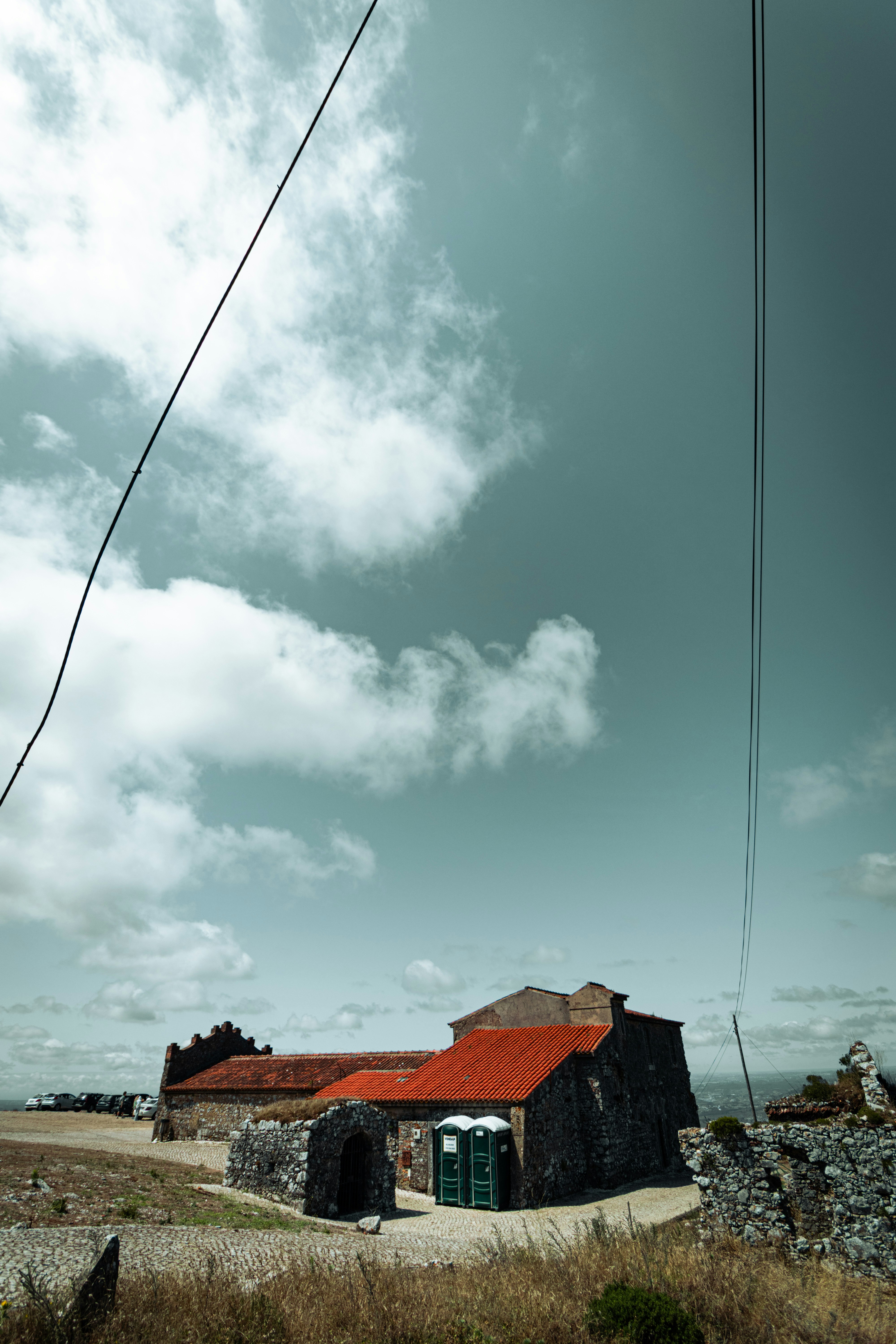 Old buildings and a cloudy sky are visible.