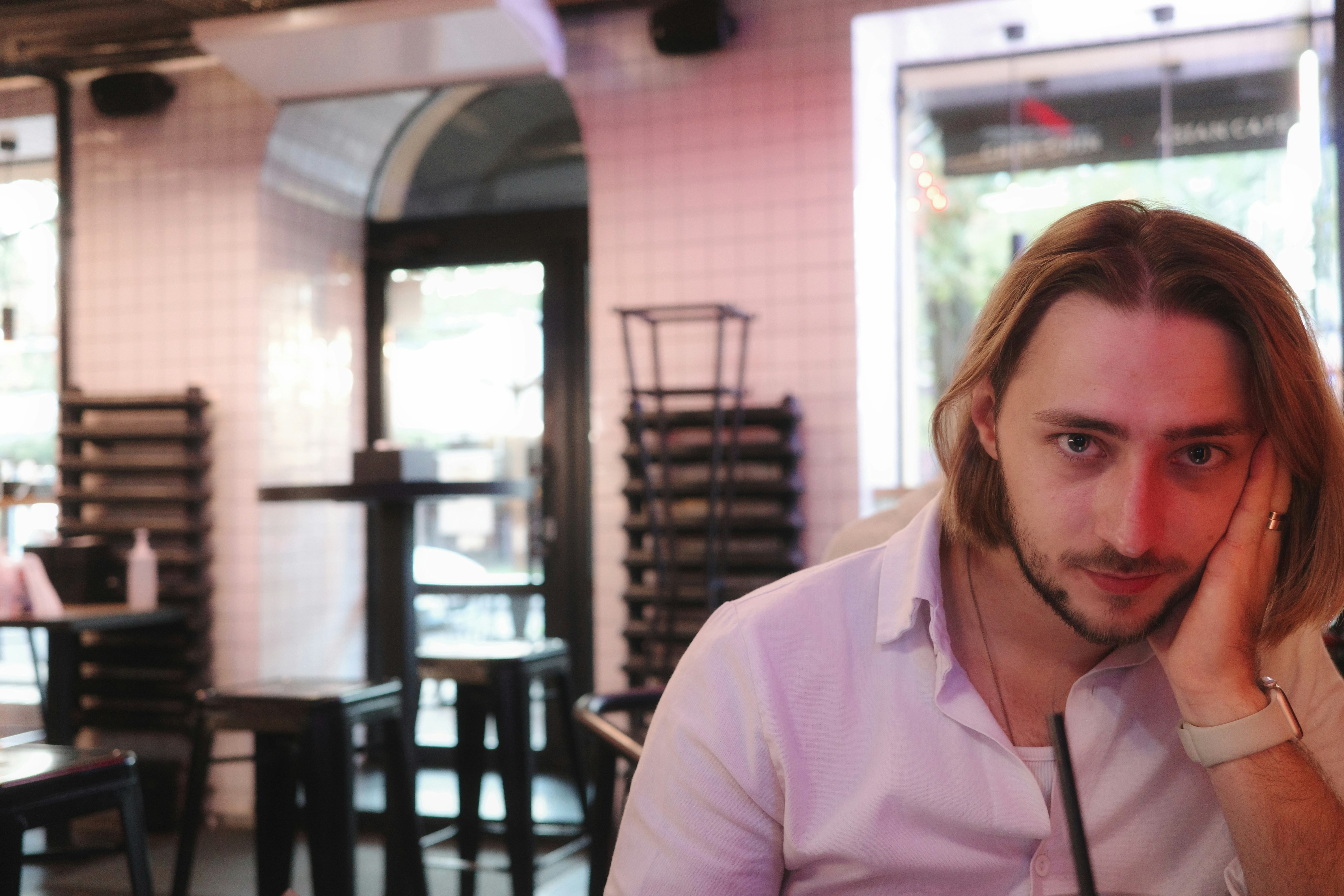 A Moment of Reflection in a Lively Café