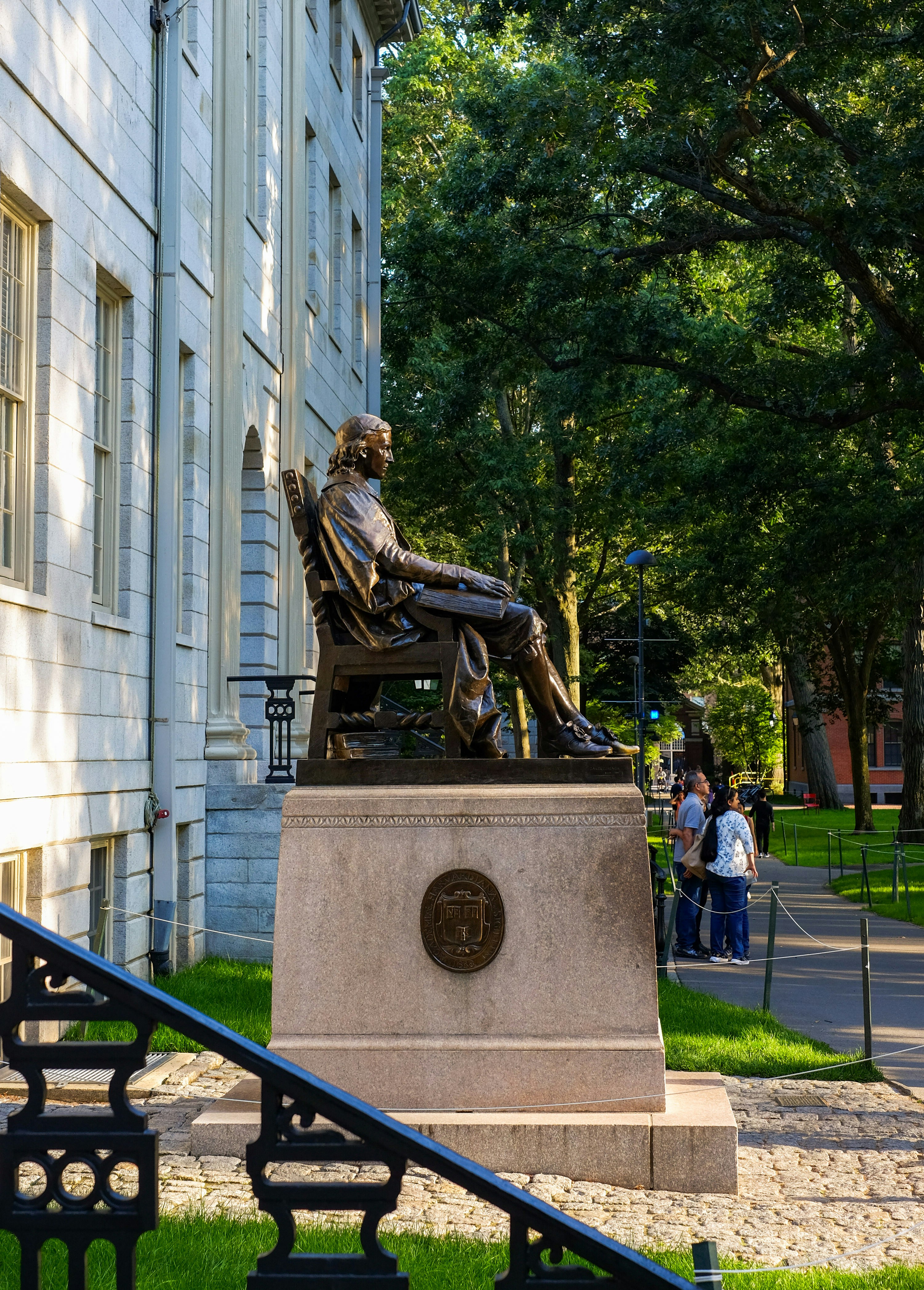 Seated Scholar in Bronze: Quiet Study by the University Walkway