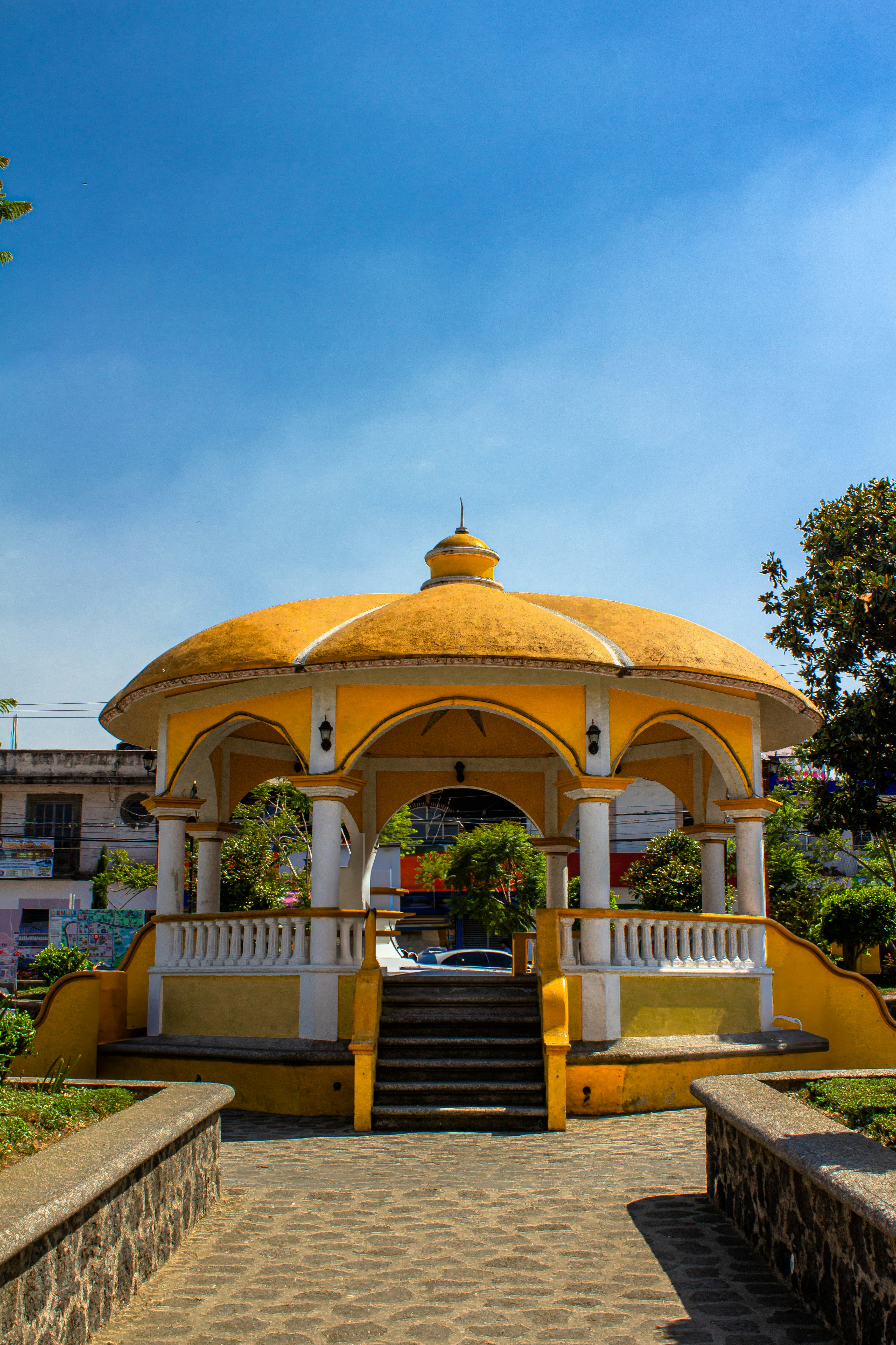 Thalittlemarc. CMG Pictures. | A yellow bandstand stands in a sunny park.