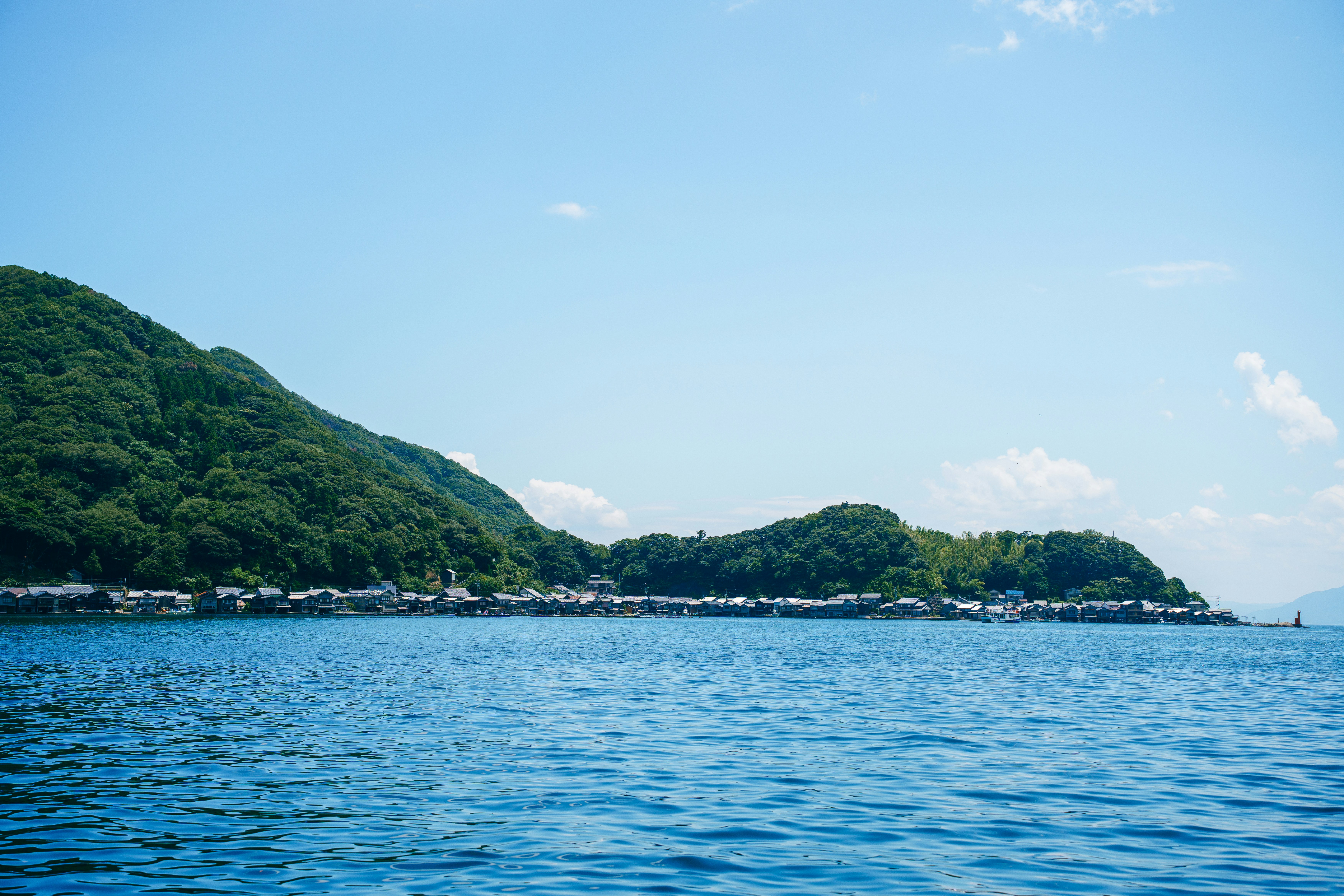 Blue ocean meets green mountain.